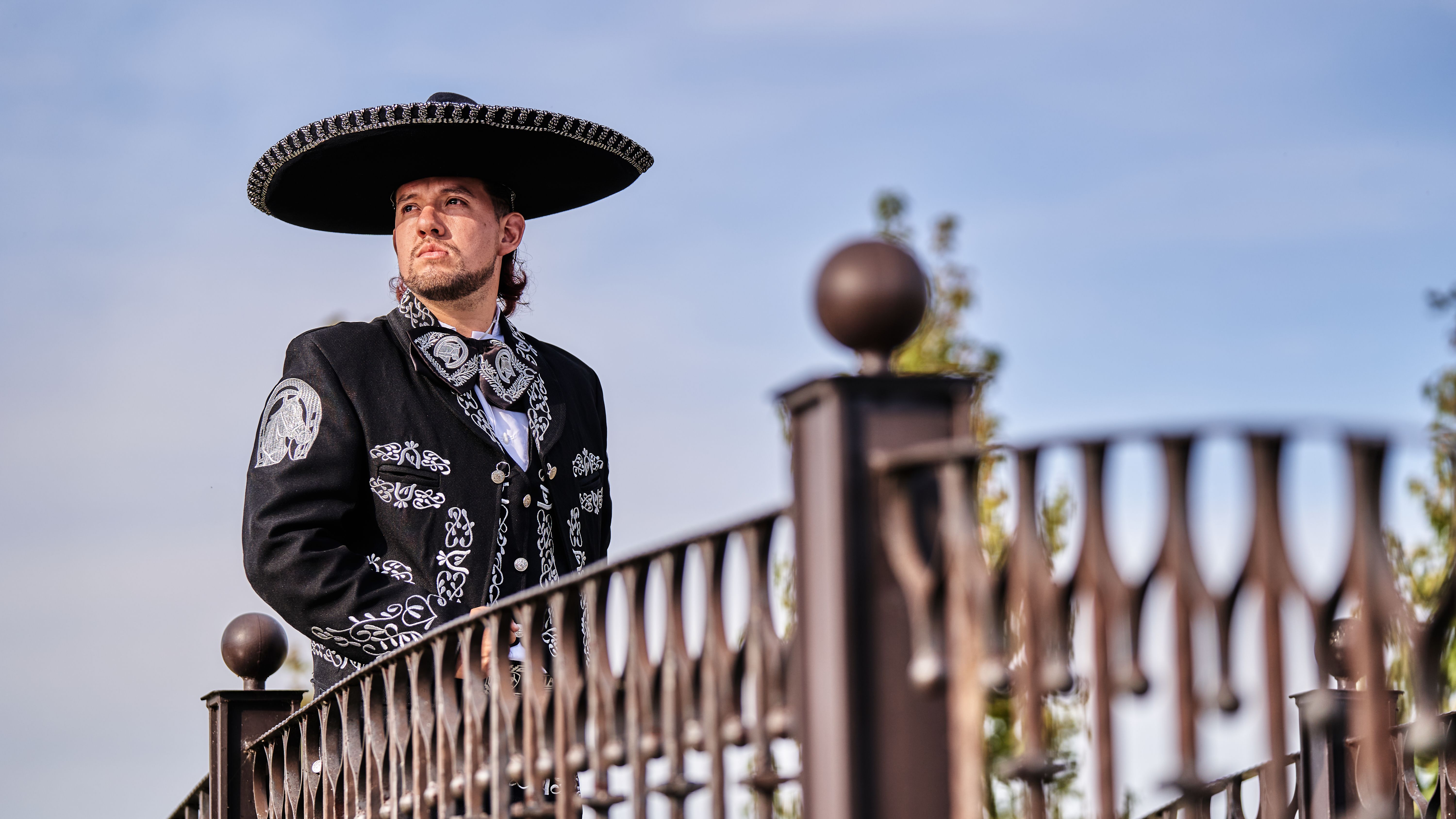 Man in Traditional Charro Attire on Bridge · Free Stock Photo