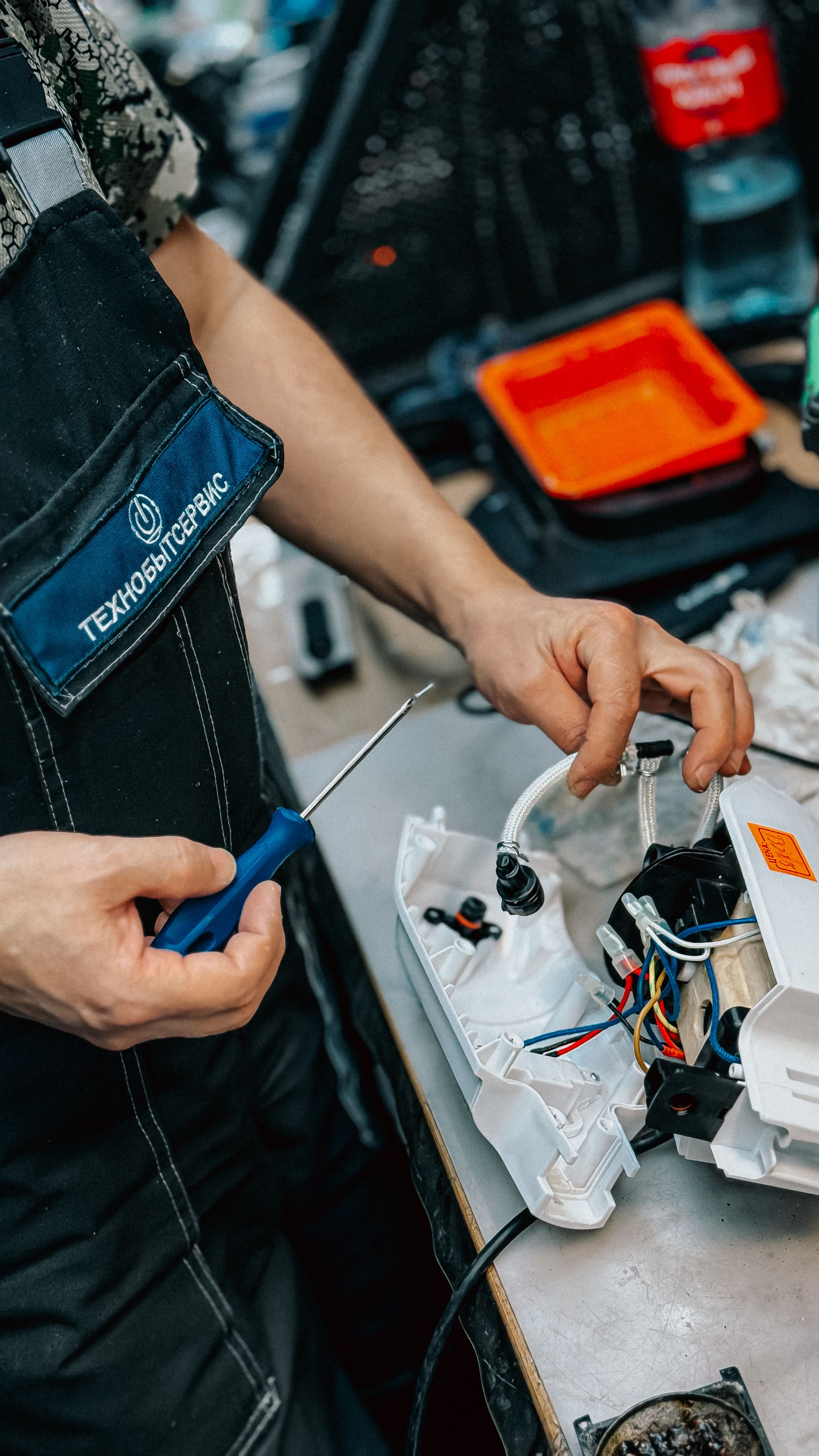 Technician Repairing Electrical Device in Workshop · Free Stock Photo