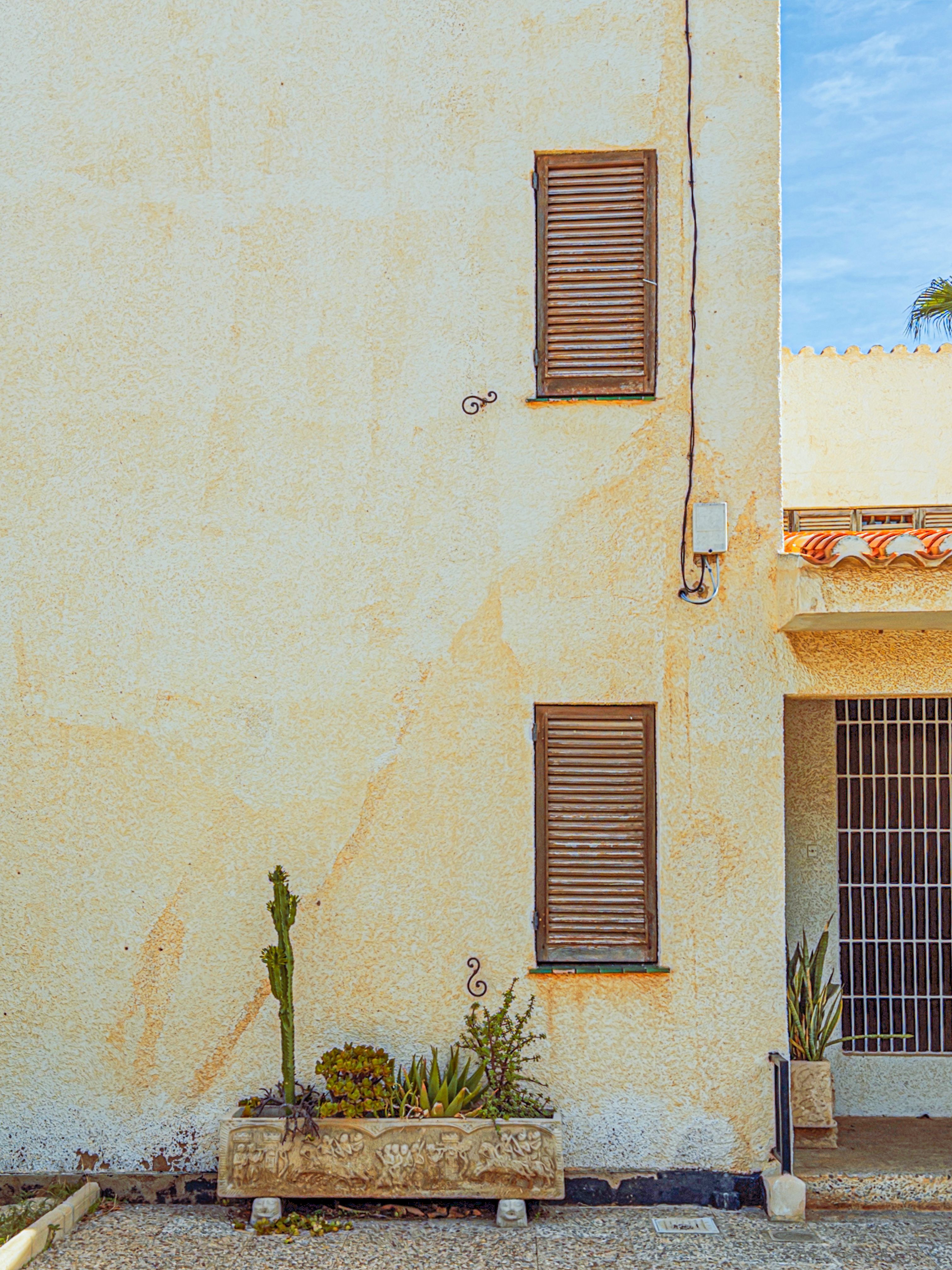 Charming Spanish Courtyard Facade with Shutters · Free Stock Photo