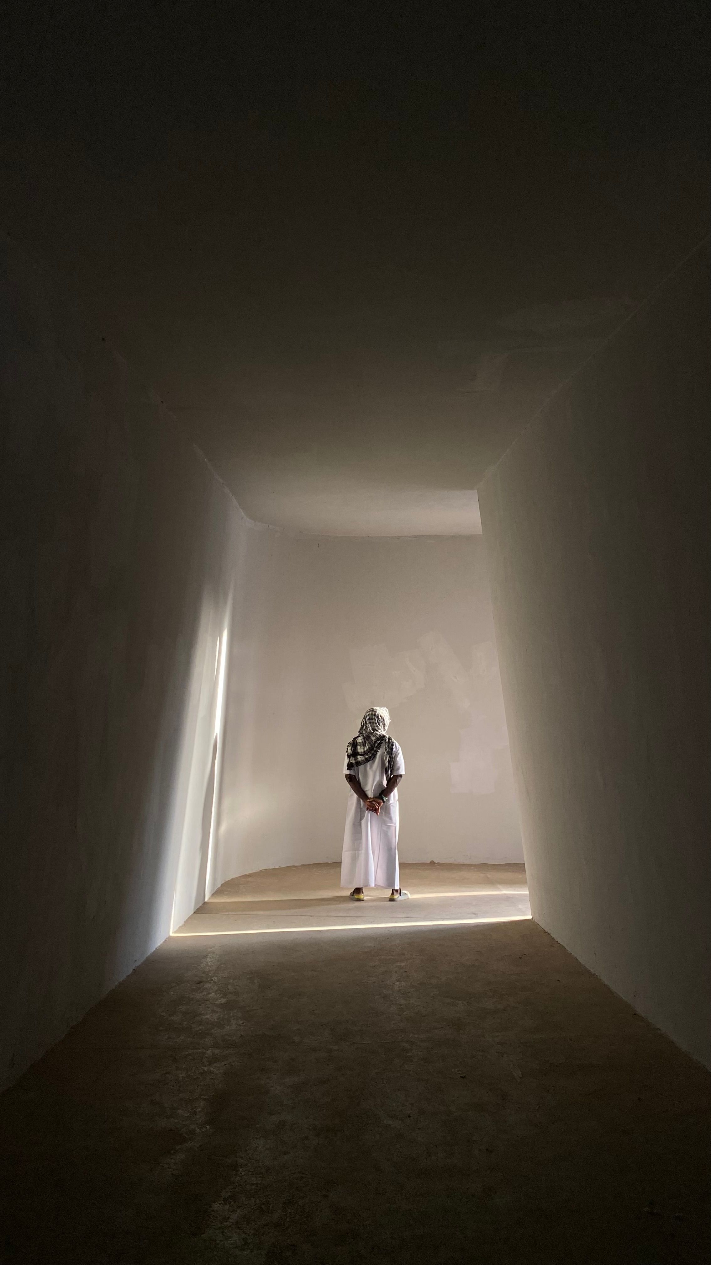 Solitary Figure in Minimalist Hallway Lighting · Free Stock Photo