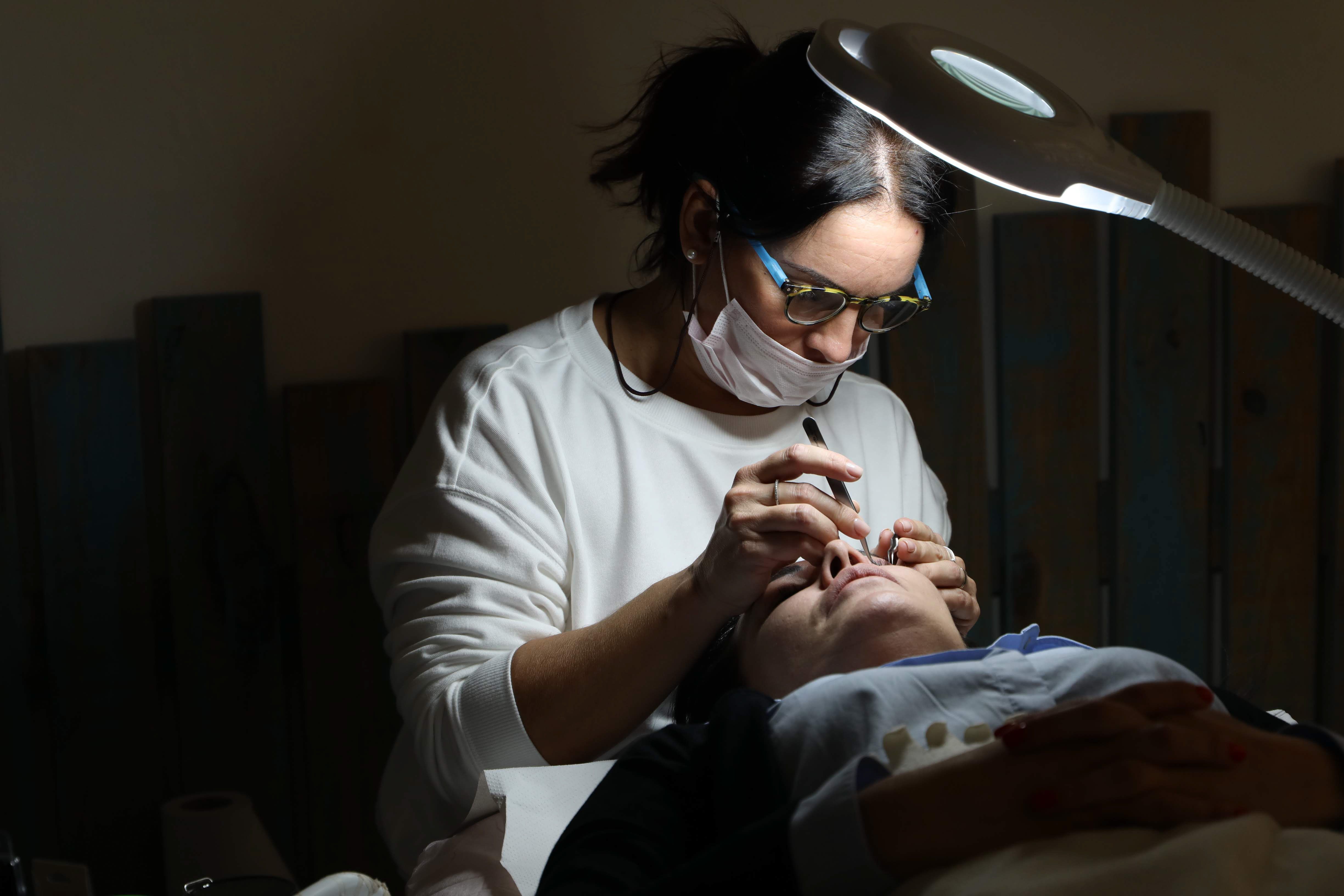 Cosmetologist Performing Eyelash Extension on Client · Free Stock Photo