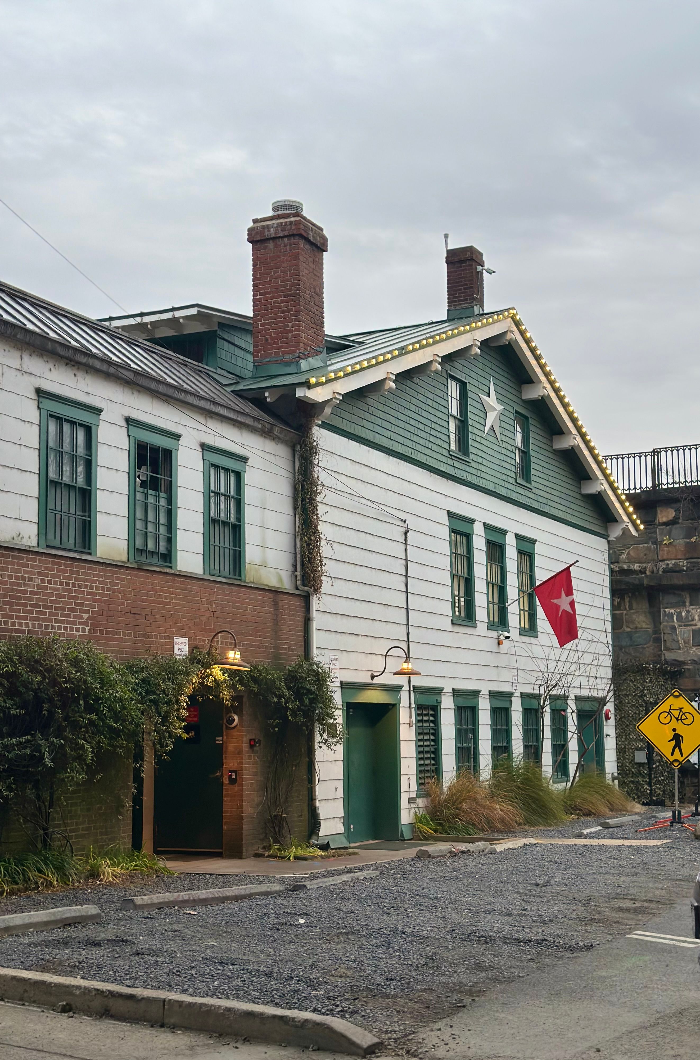Historic Building with Green Trim and Red Flag · Free Stock Photo