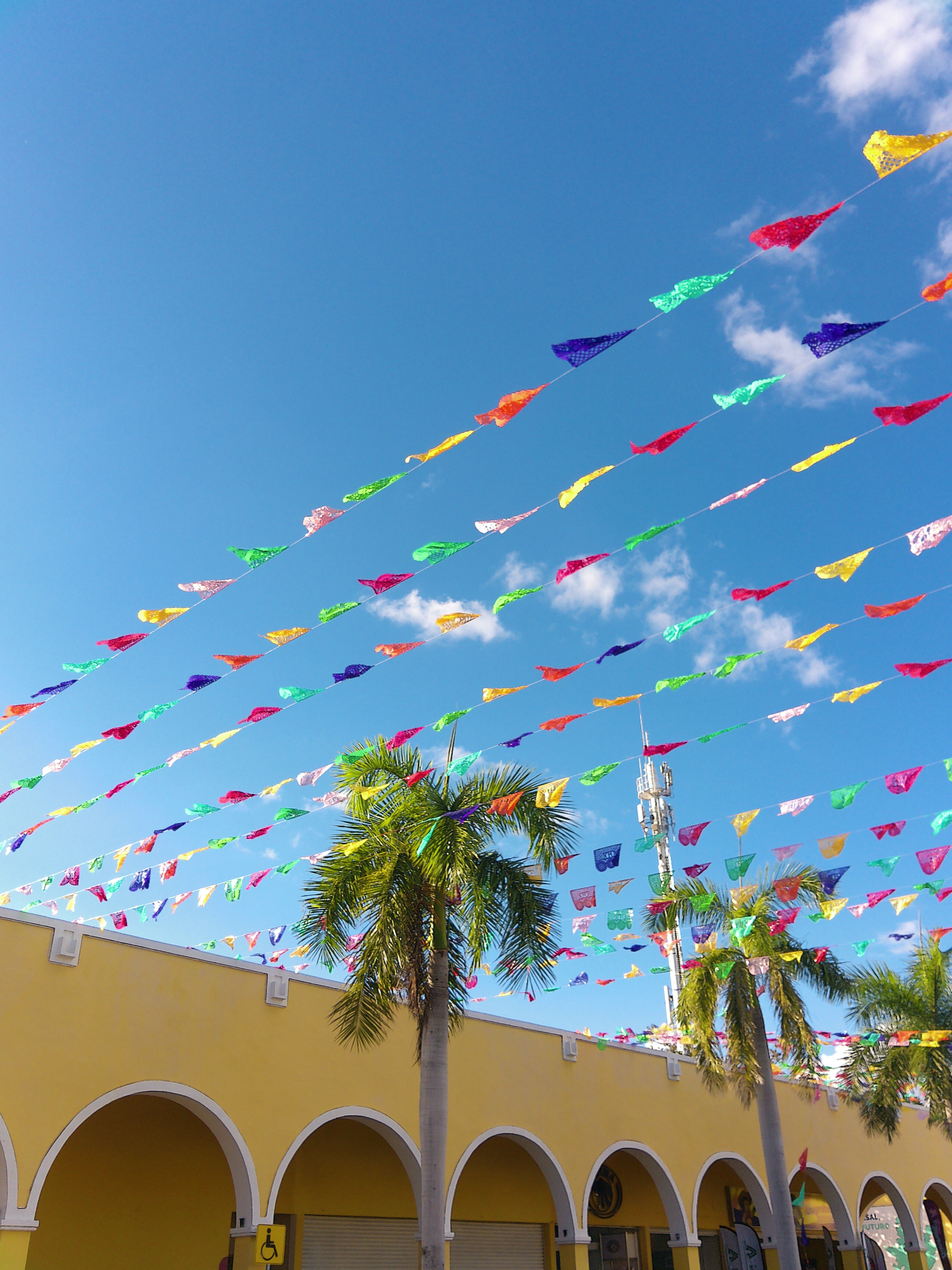 Colorful Fiesta Flags Against Blue Sky · Free Stock Photo