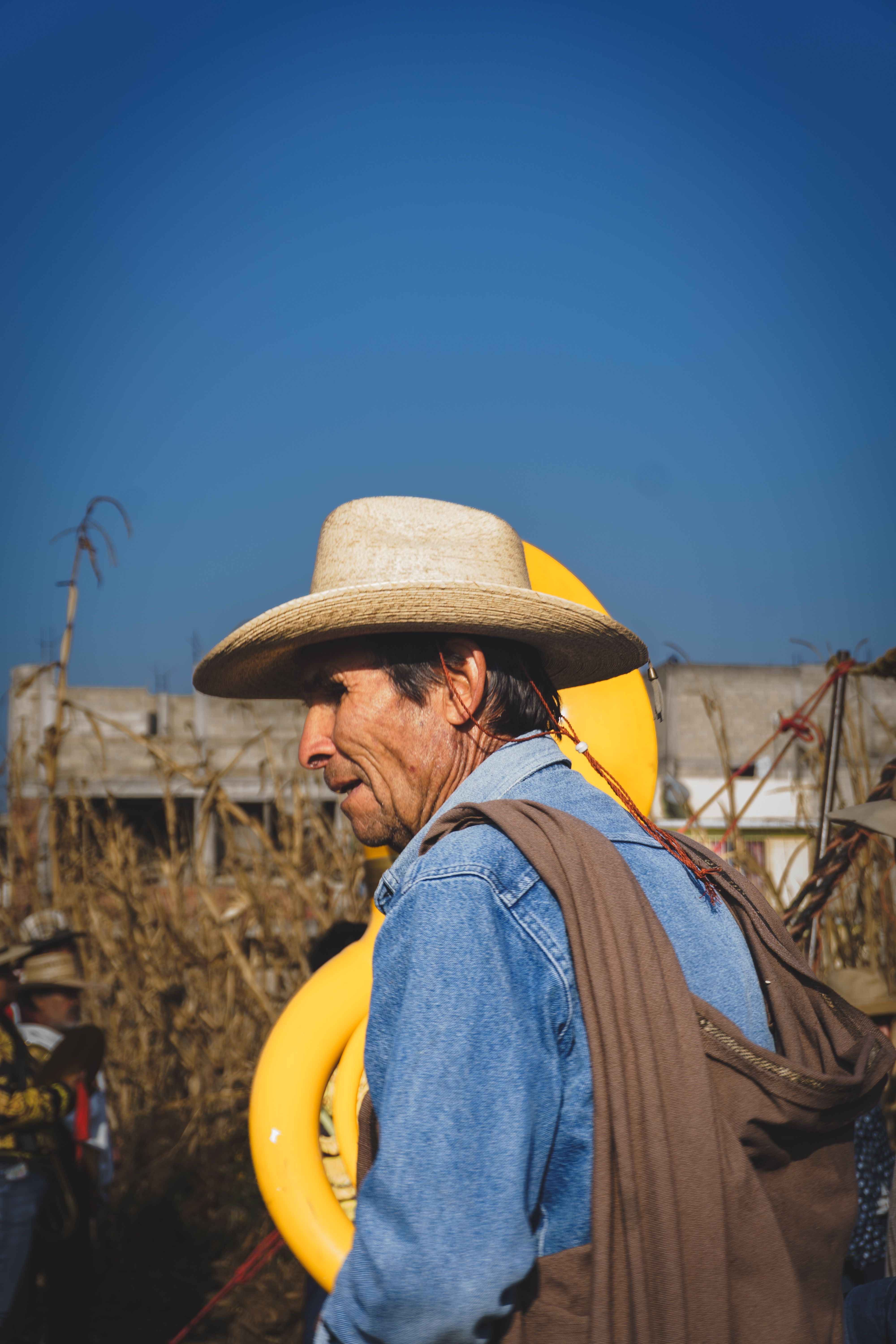 Rural Man in Denim with Straw Hat Outdoors · Free Stock Photo