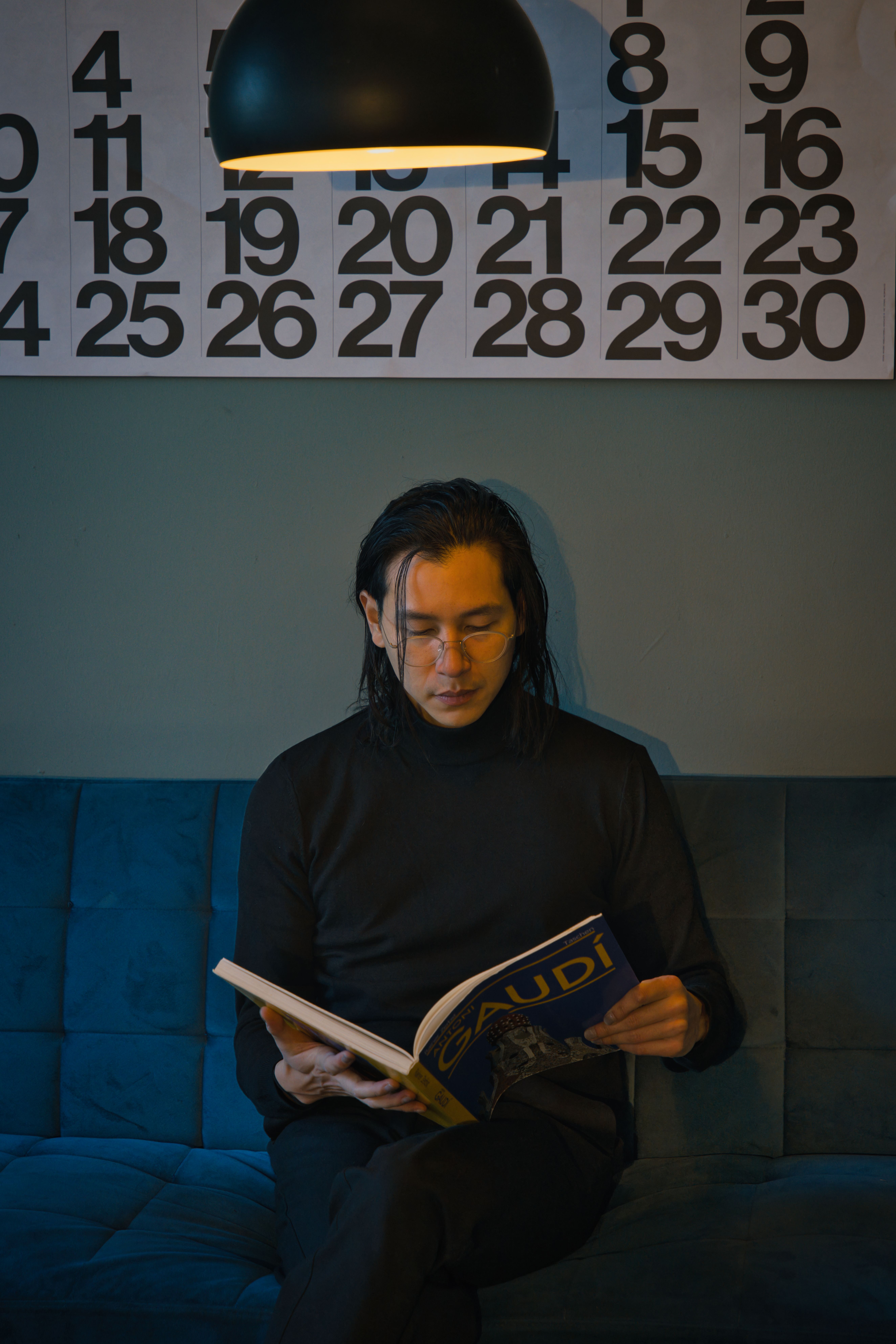 Man Reading Book Under Modern Lamp in Berlin · Free Stock Photo