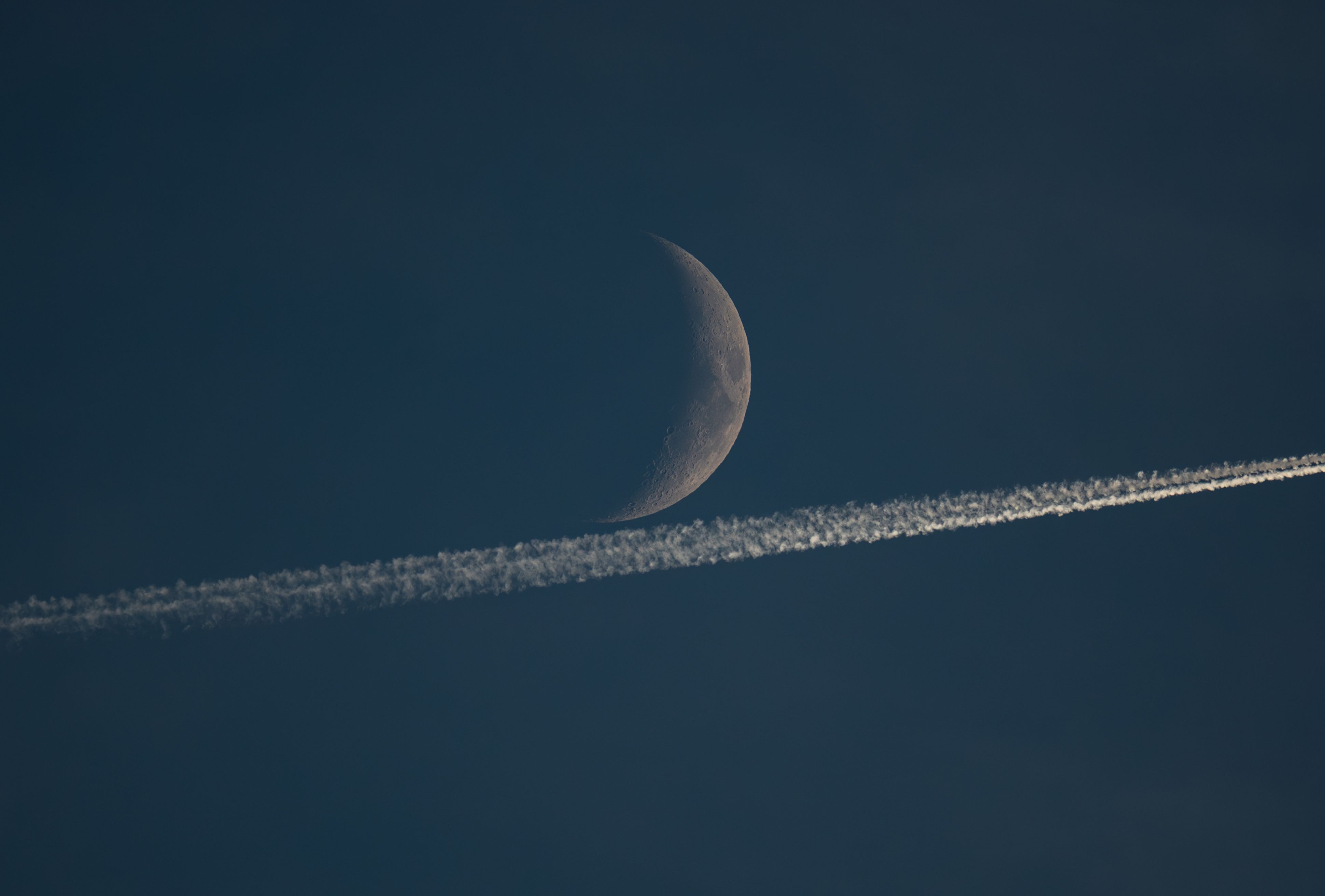 Crescent Moon with Contrail in Night Sky · Free Stock Photo