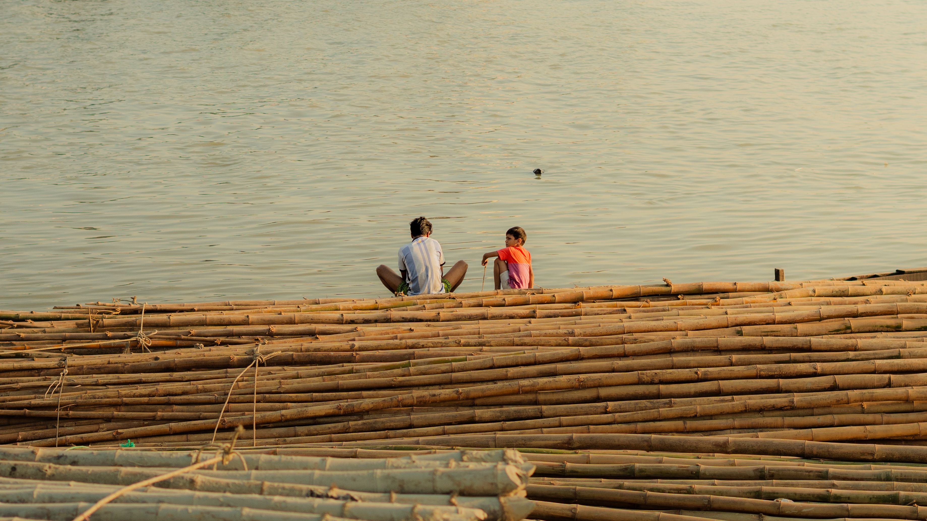 Serene Riverside Scene with Bamboo Rafts in Chittagong · Free Stock Photo