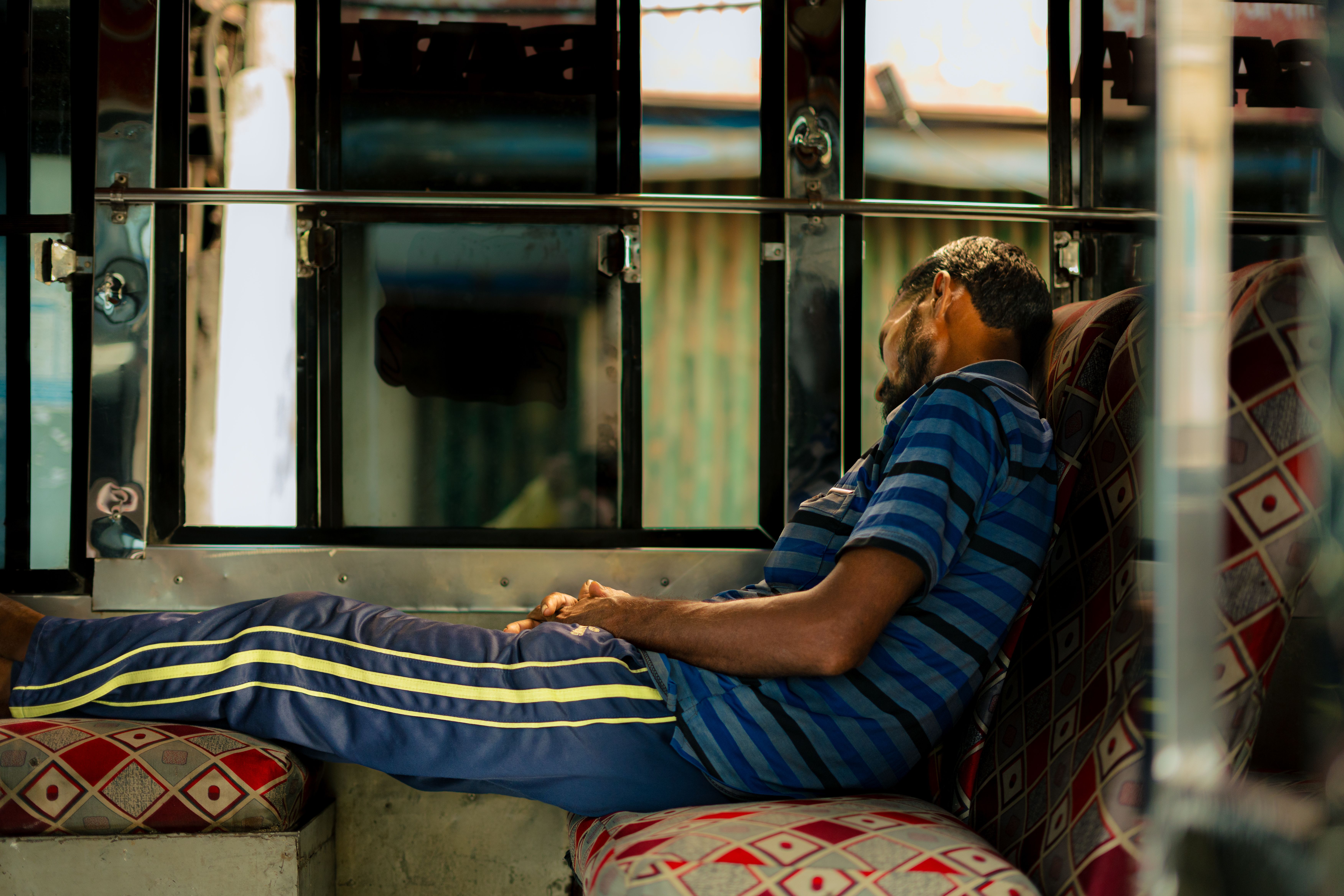 Man resting on bus in Chittagong, Bangladesh · Free Stock Photo