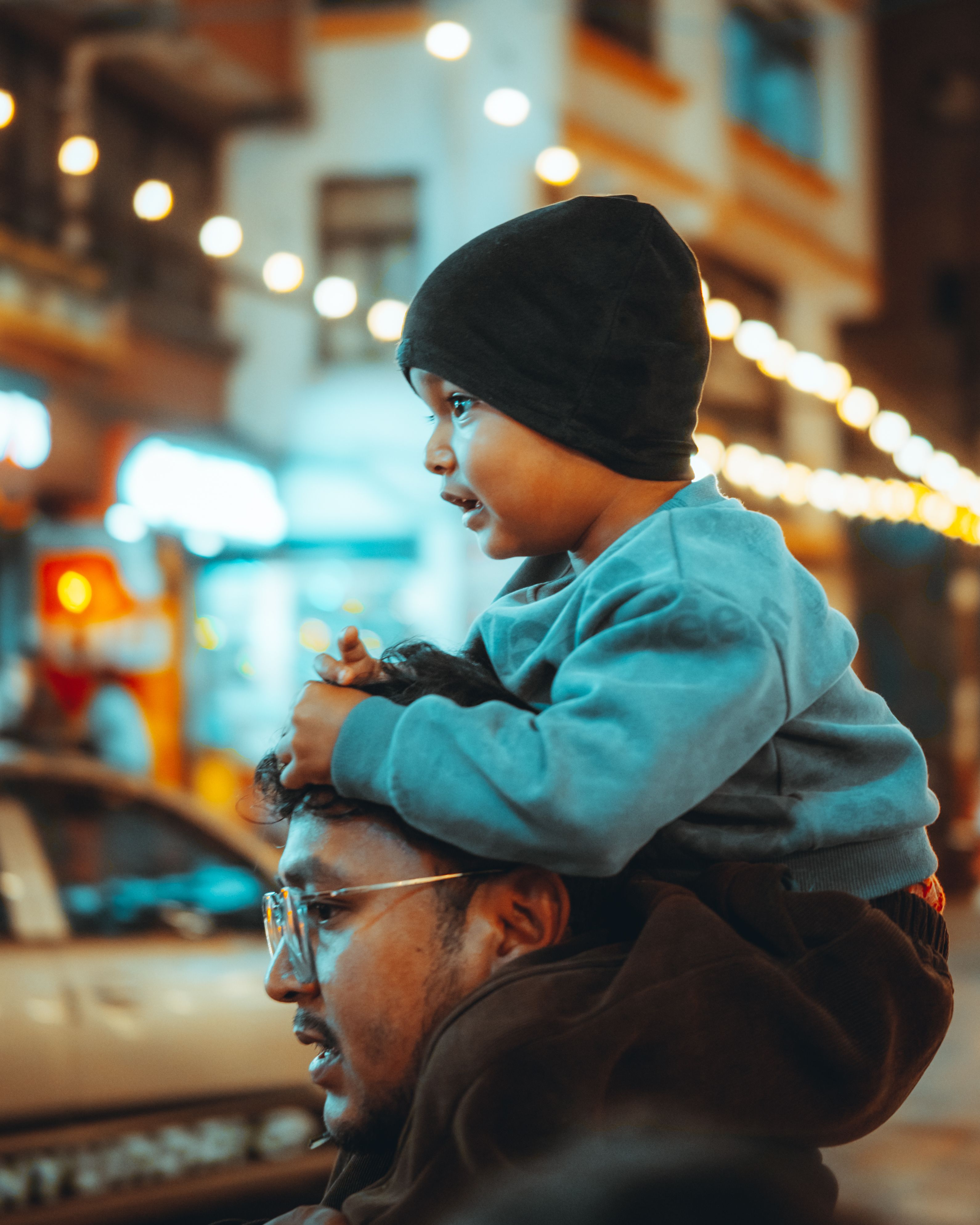 Father and Child Enjoying a Night Out · Free Stock Photo