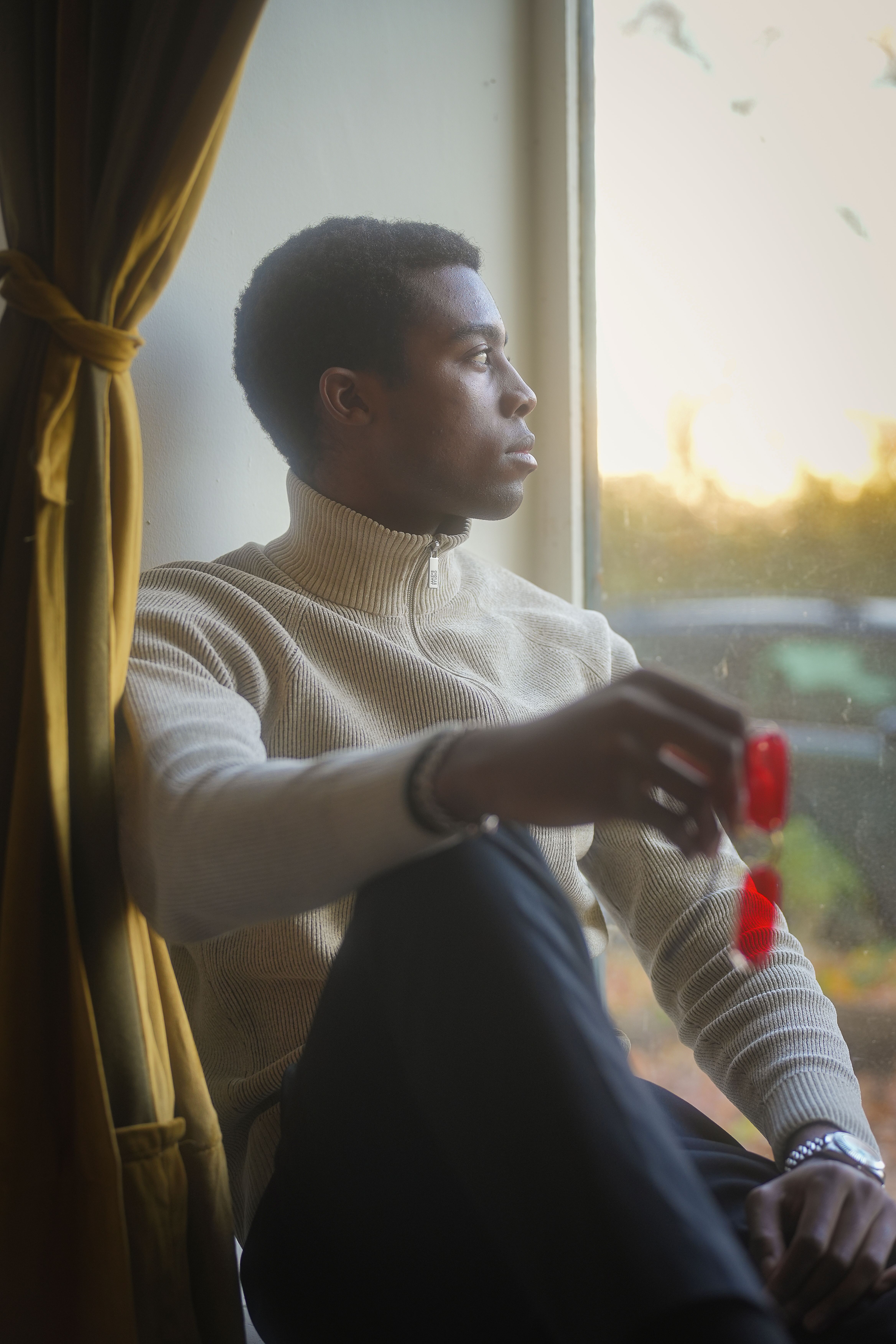Reflective Man Sitting by Window at Sunset · Free Stock Photo
