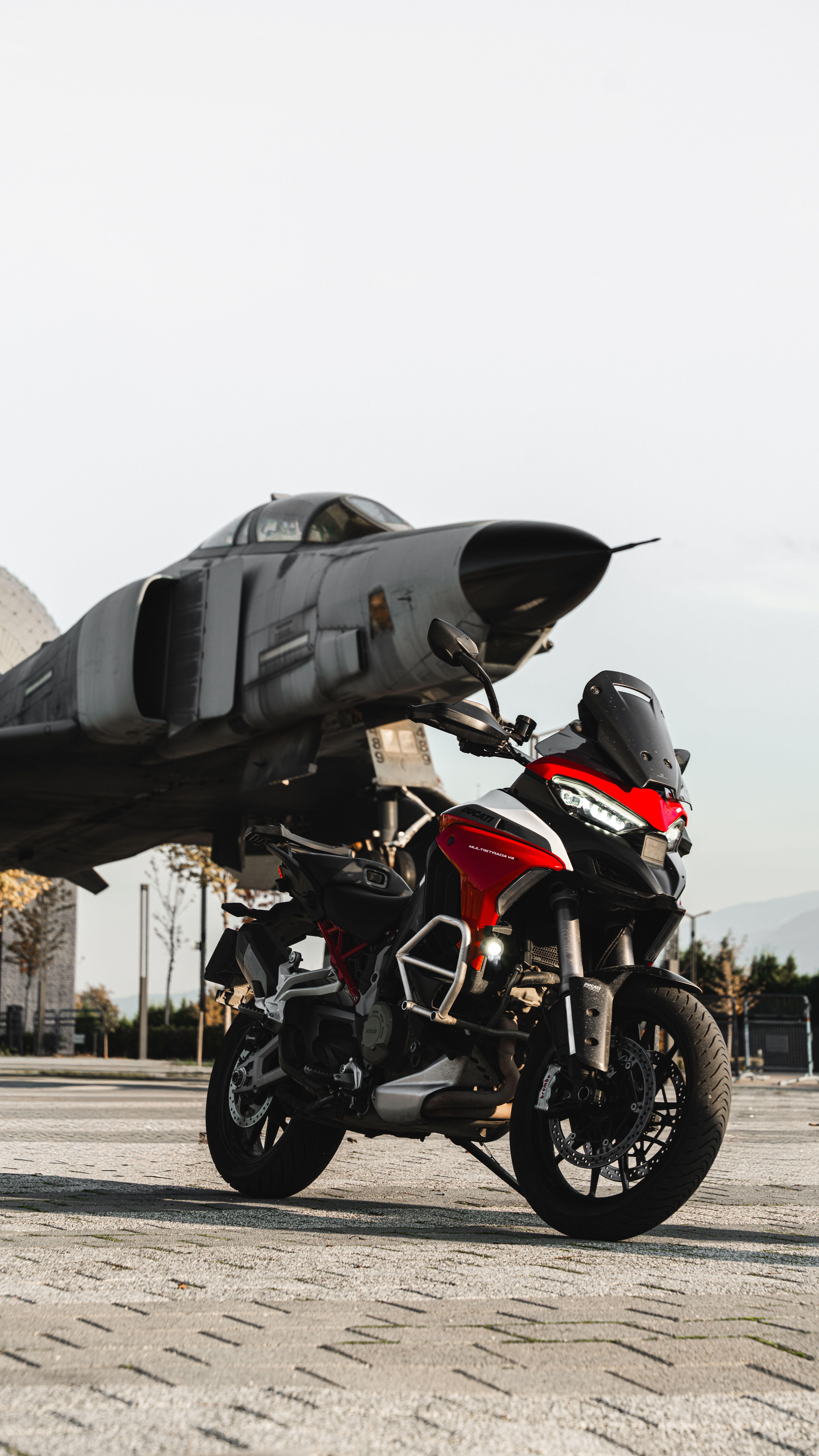 Modern Motorcycle and Jet Fighter Display Outdoors · Free Stock Photo