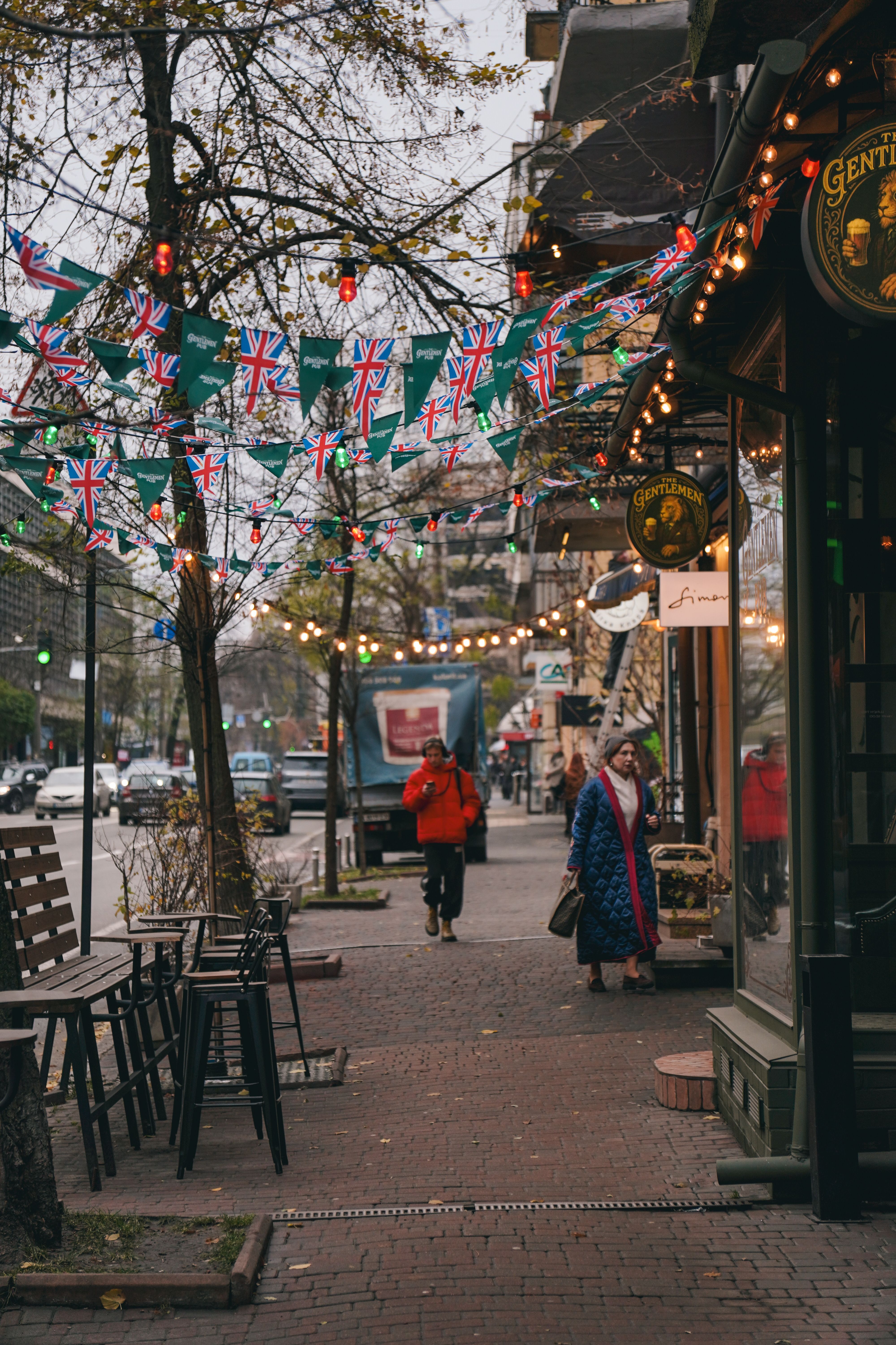 Charming Street Scene in Kyiv with Flags and Lights · Free Stock Photo