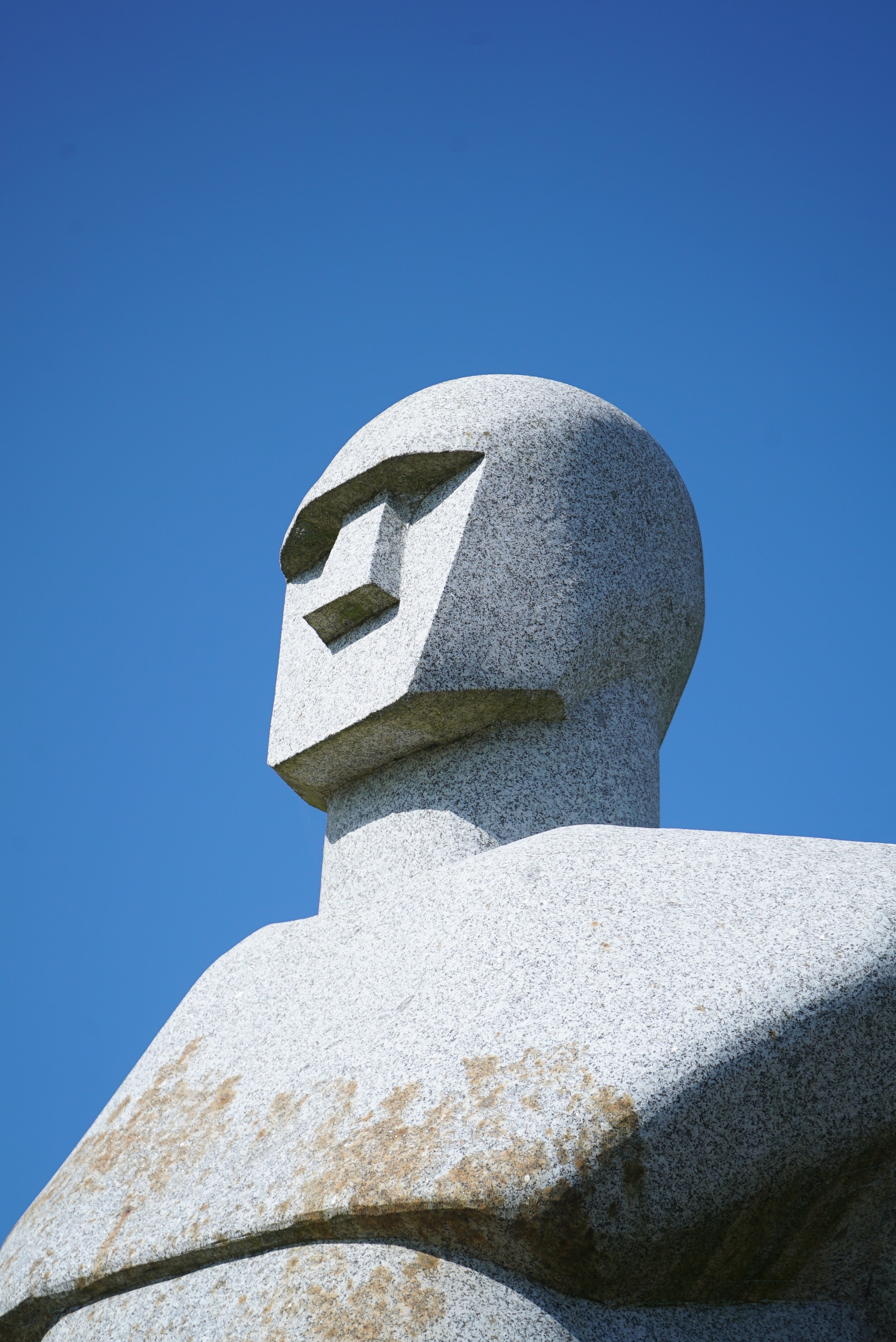 Granite Statue Against Clear Blue Sky · Free Stock Photo