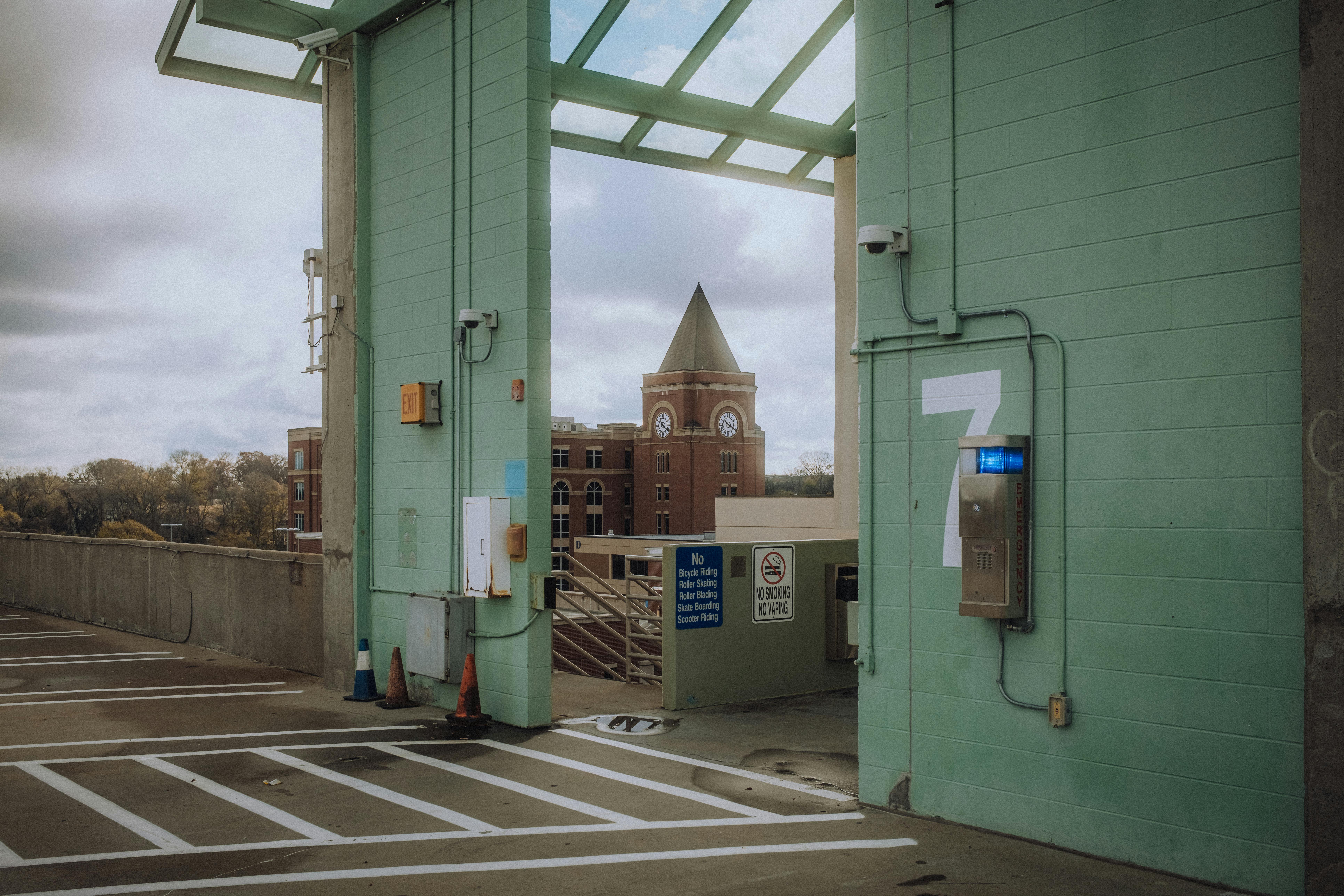 Urban Rooftop View of Parking Garage with Clock Tower · Free Stock Photo