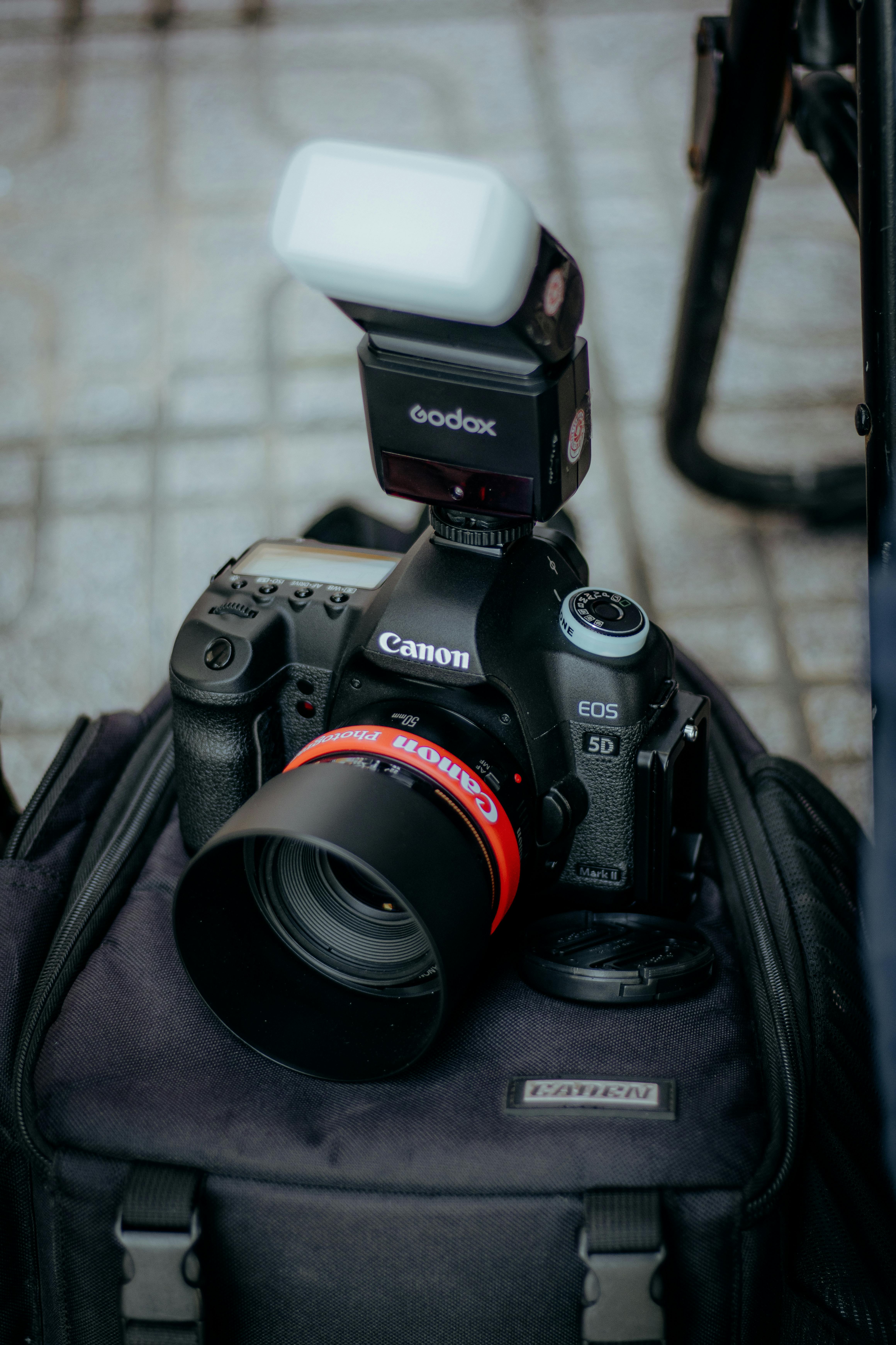 Professional Camera with Flash on Backpack Outdoors · Free Stock Photo