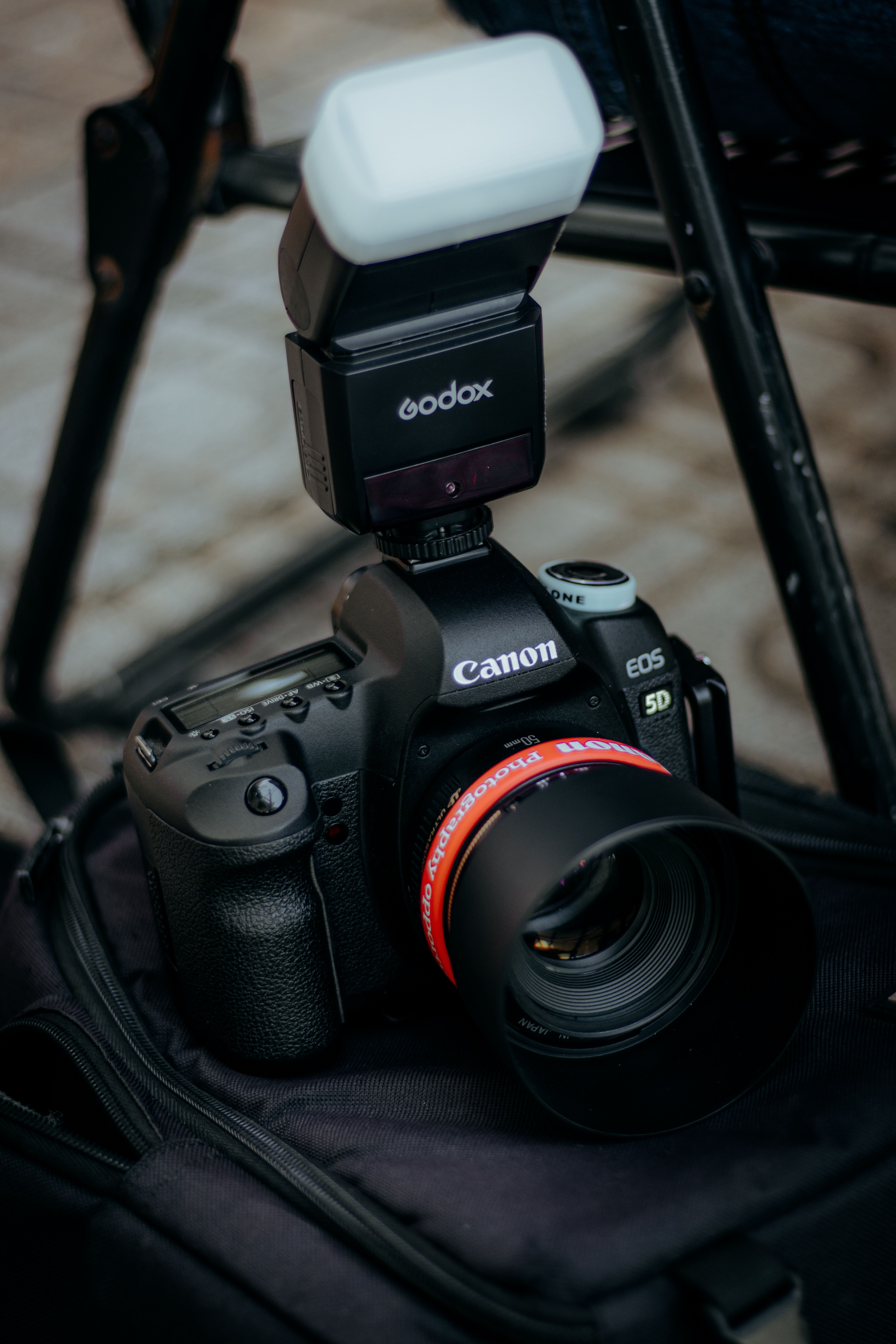 DSLR Camera with Flash on Chair · Free Stock Photo