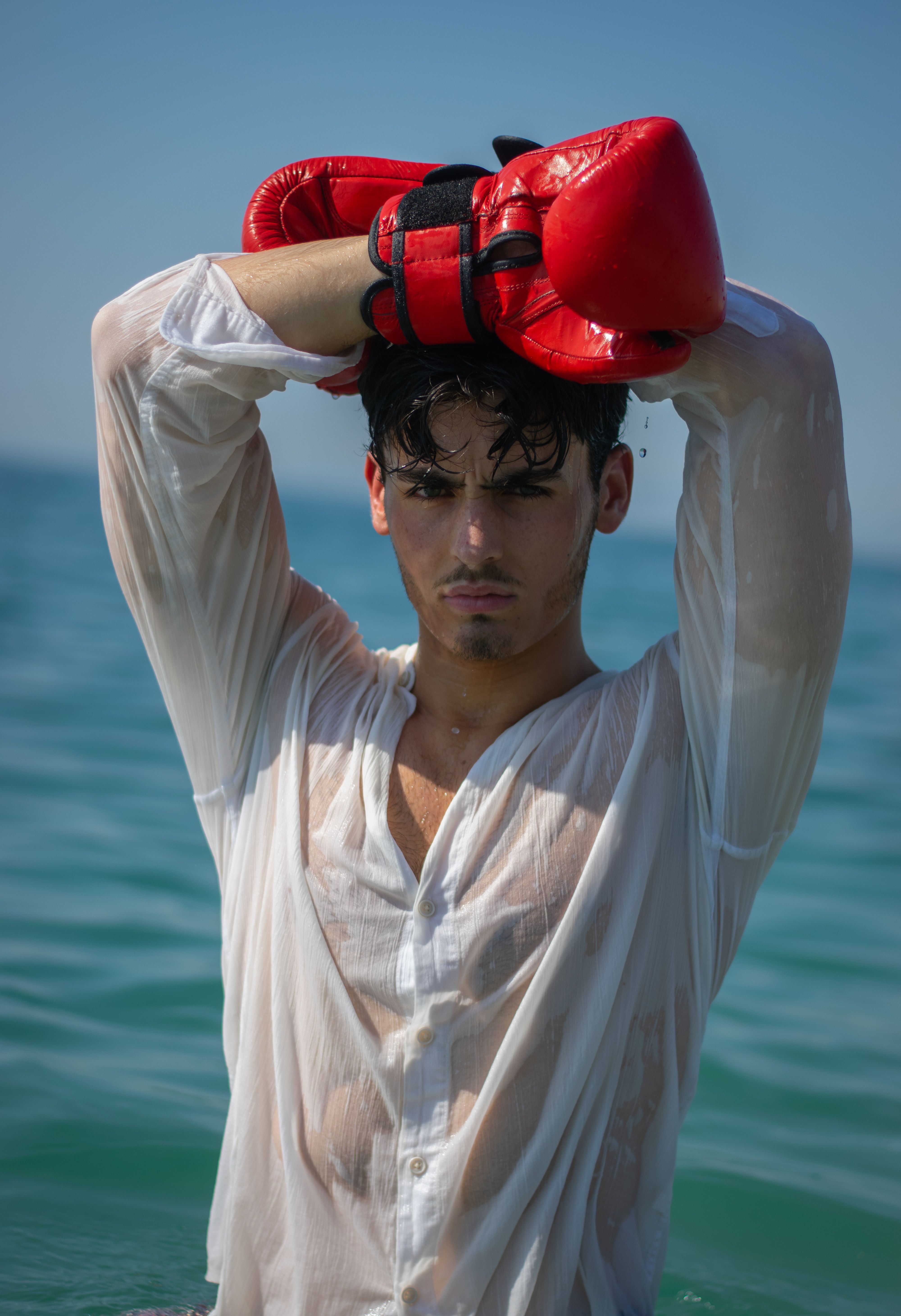 Young man with boxing gloves in the ocean · Free Stock Photo