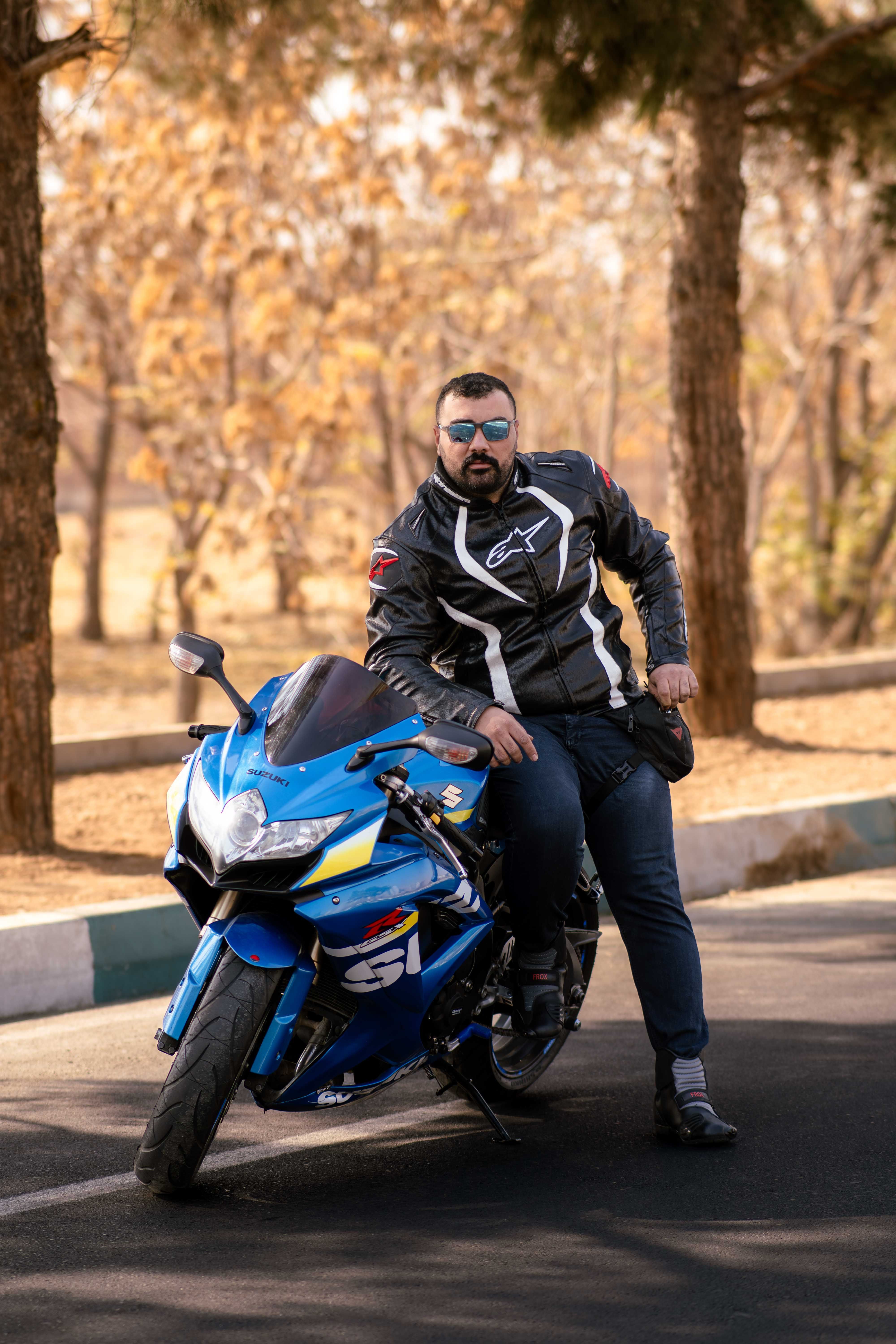 Stylish Biker Posing with Motorcycle Outdoors · Free Stock Photo