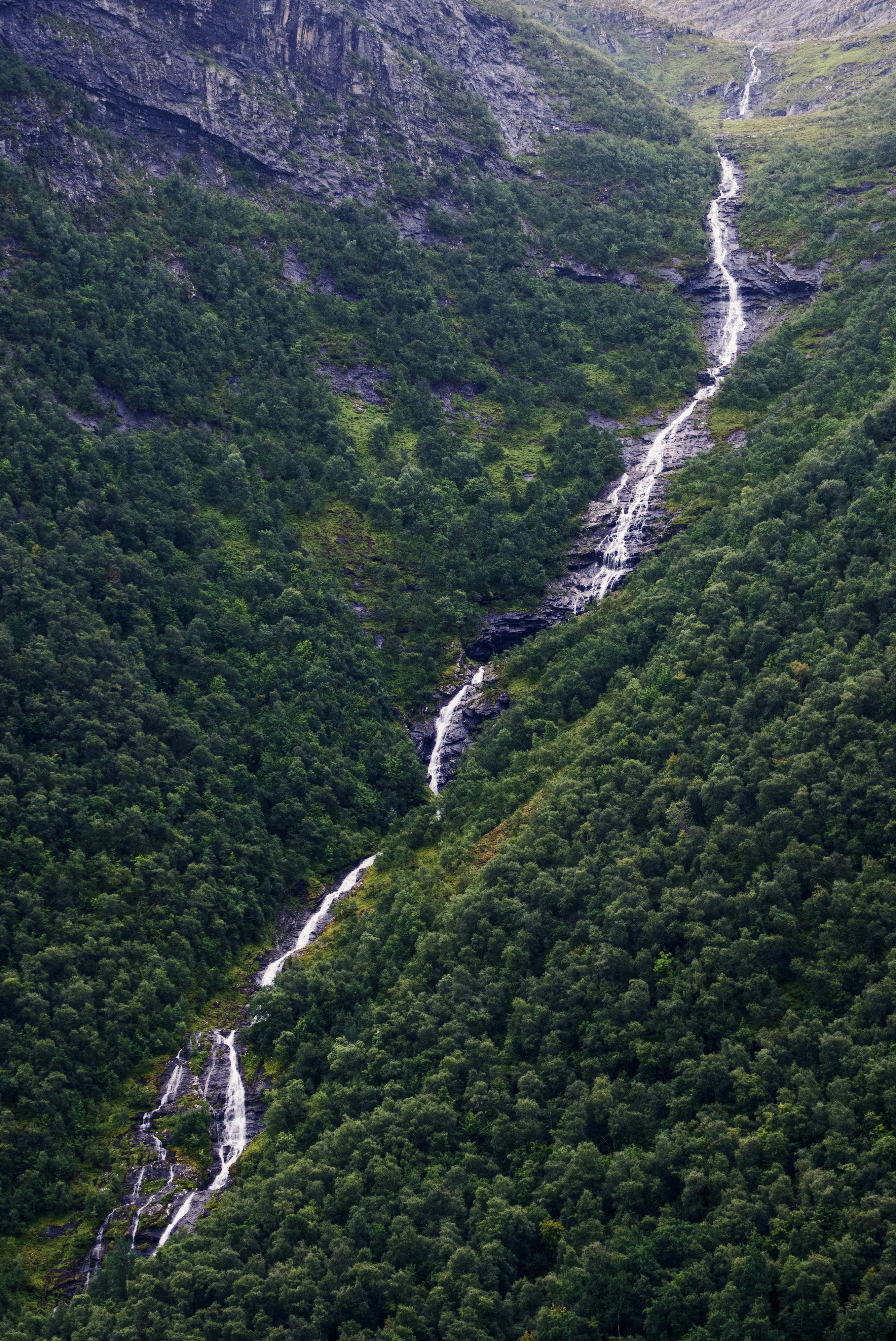 Scenic Waterfall in Lush Green Mountain Valley · Free Stock Photo