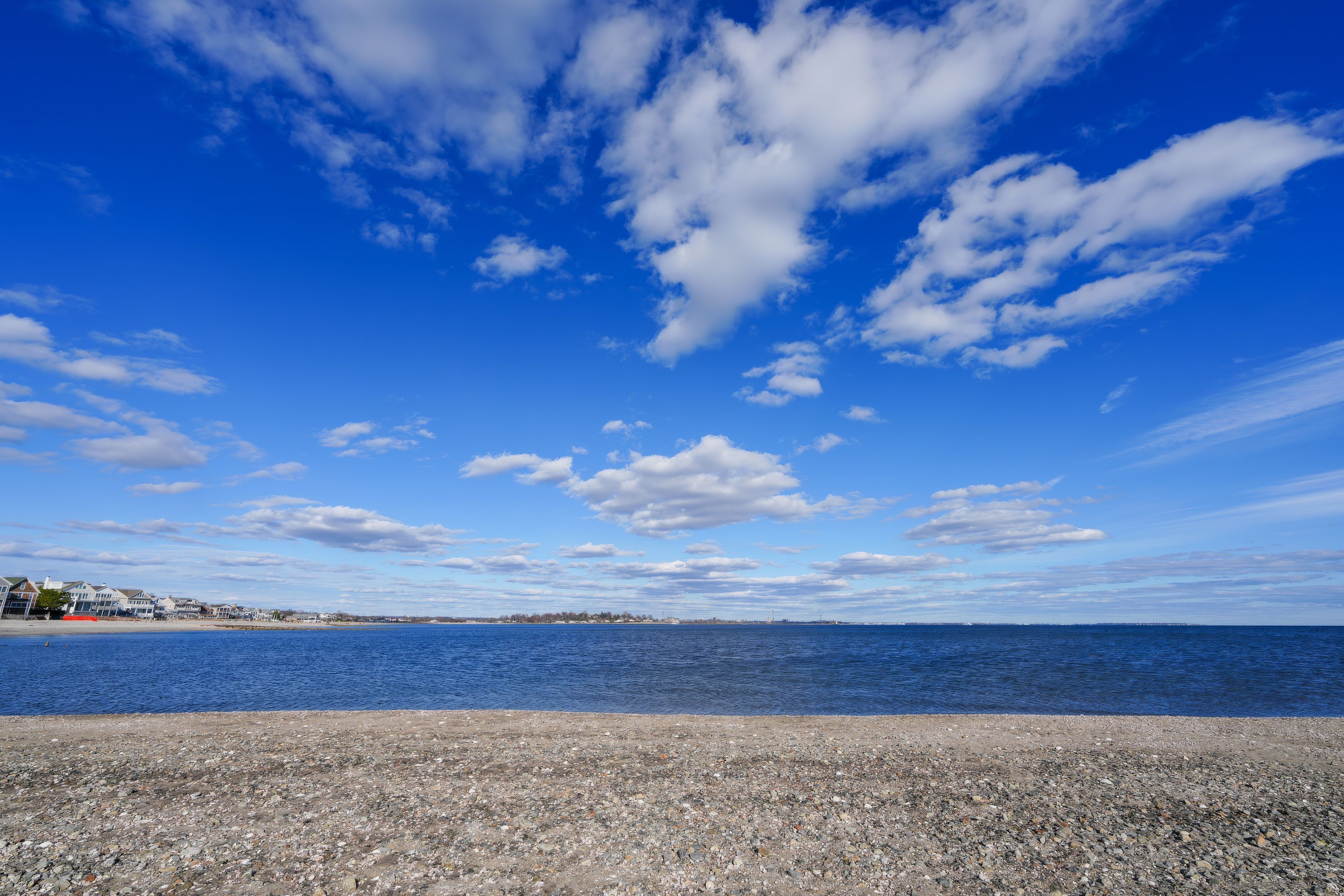 Scenic Beachfront with Blue Sky and Clouds · Free Stock Photo