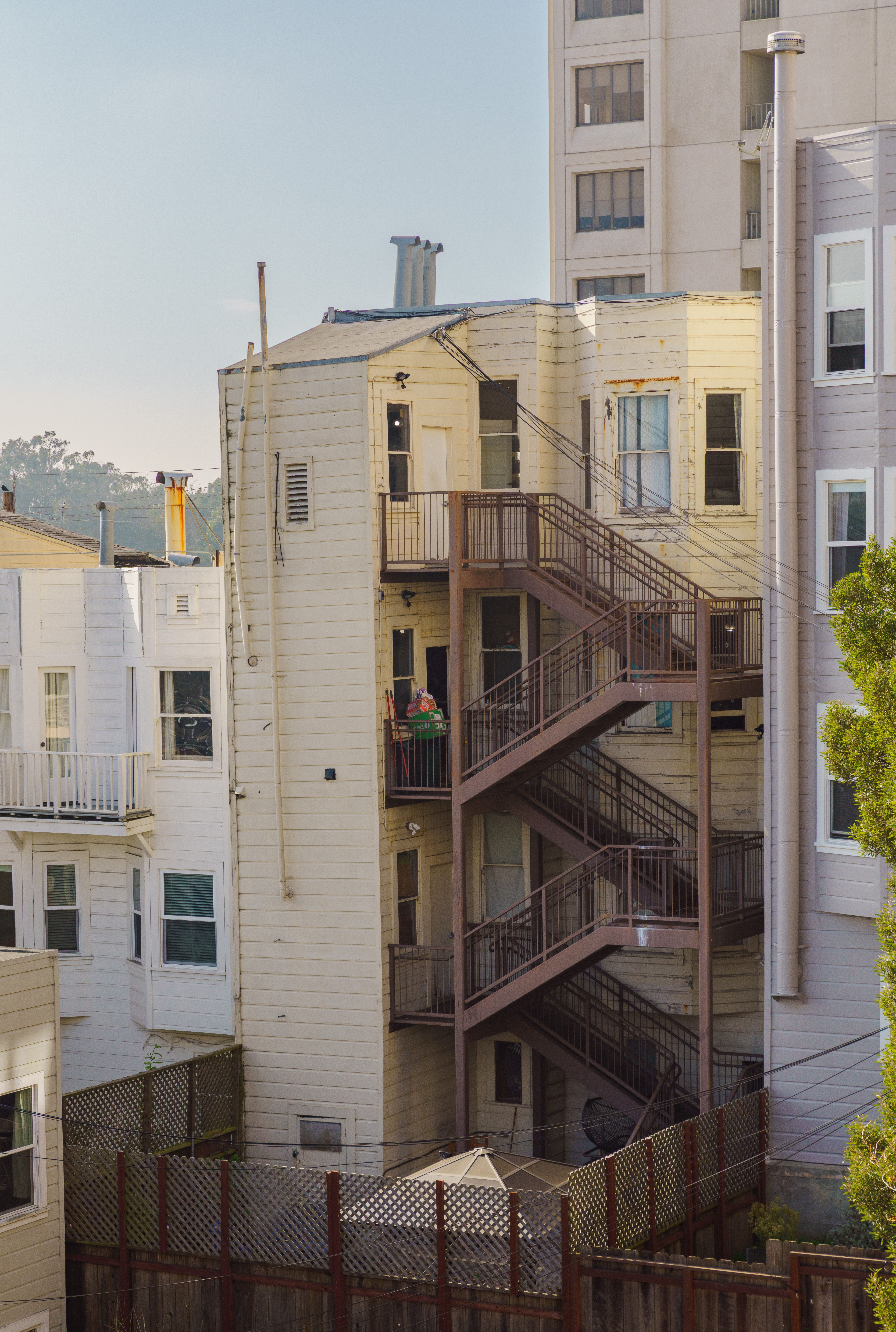 Urban apartment building with exterior stairs · Free Stock Photo