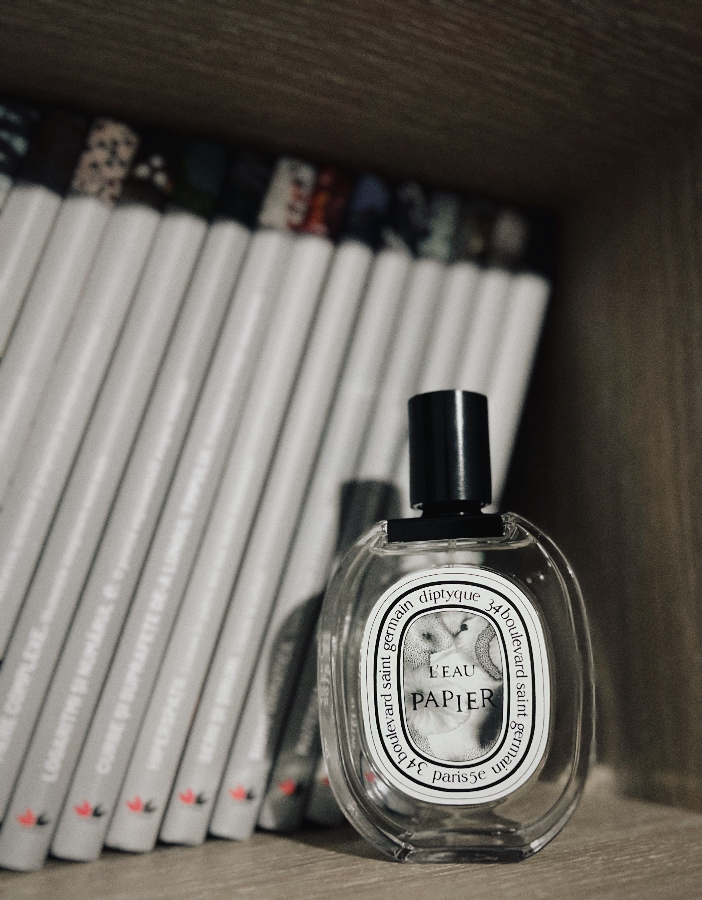 Elegant Diptyque Perfume Bottle in Cozy Home Library · Free Stock Photo