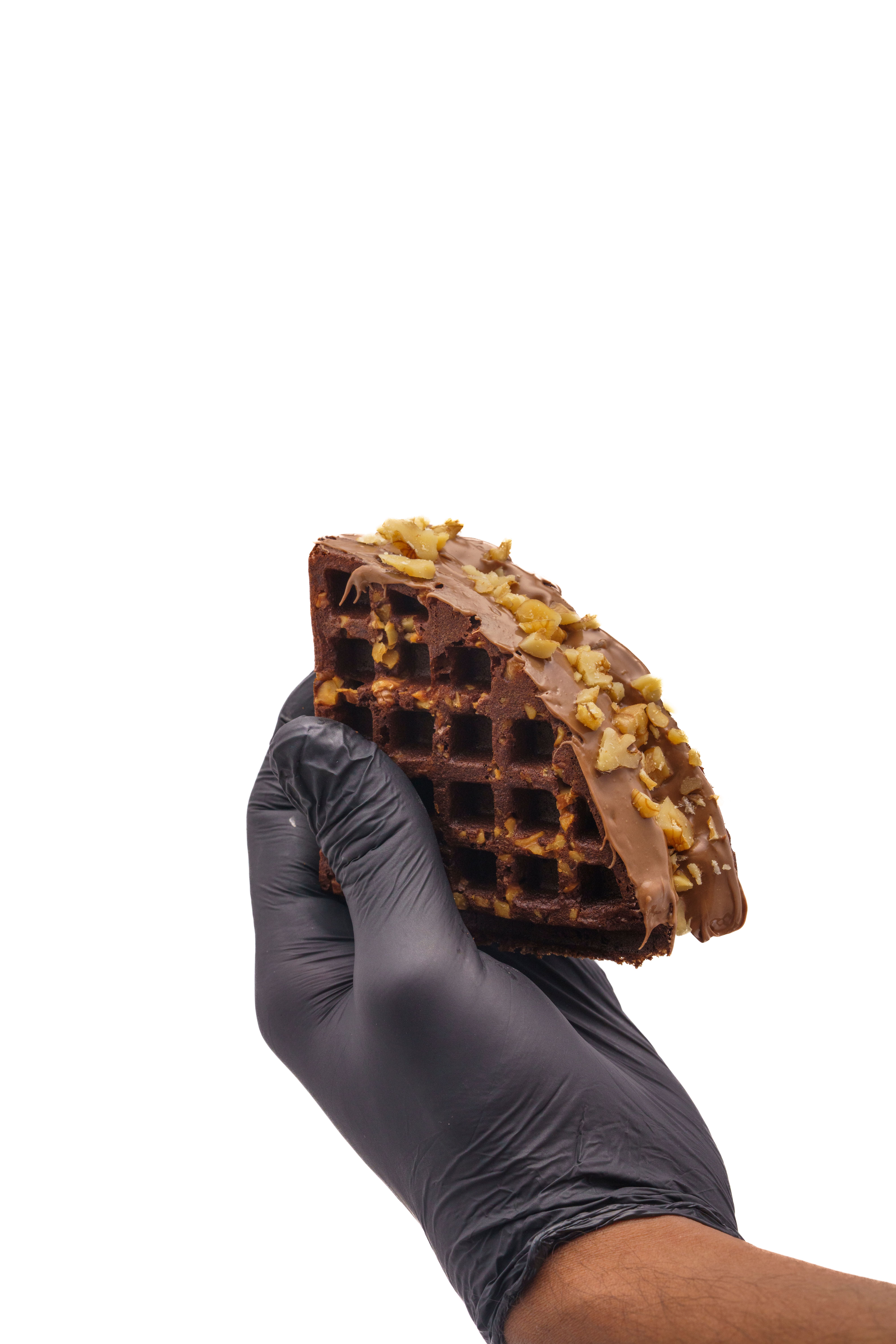 Close-up of Chocolate Waffle in Gloved Hand · Free Stock Photo