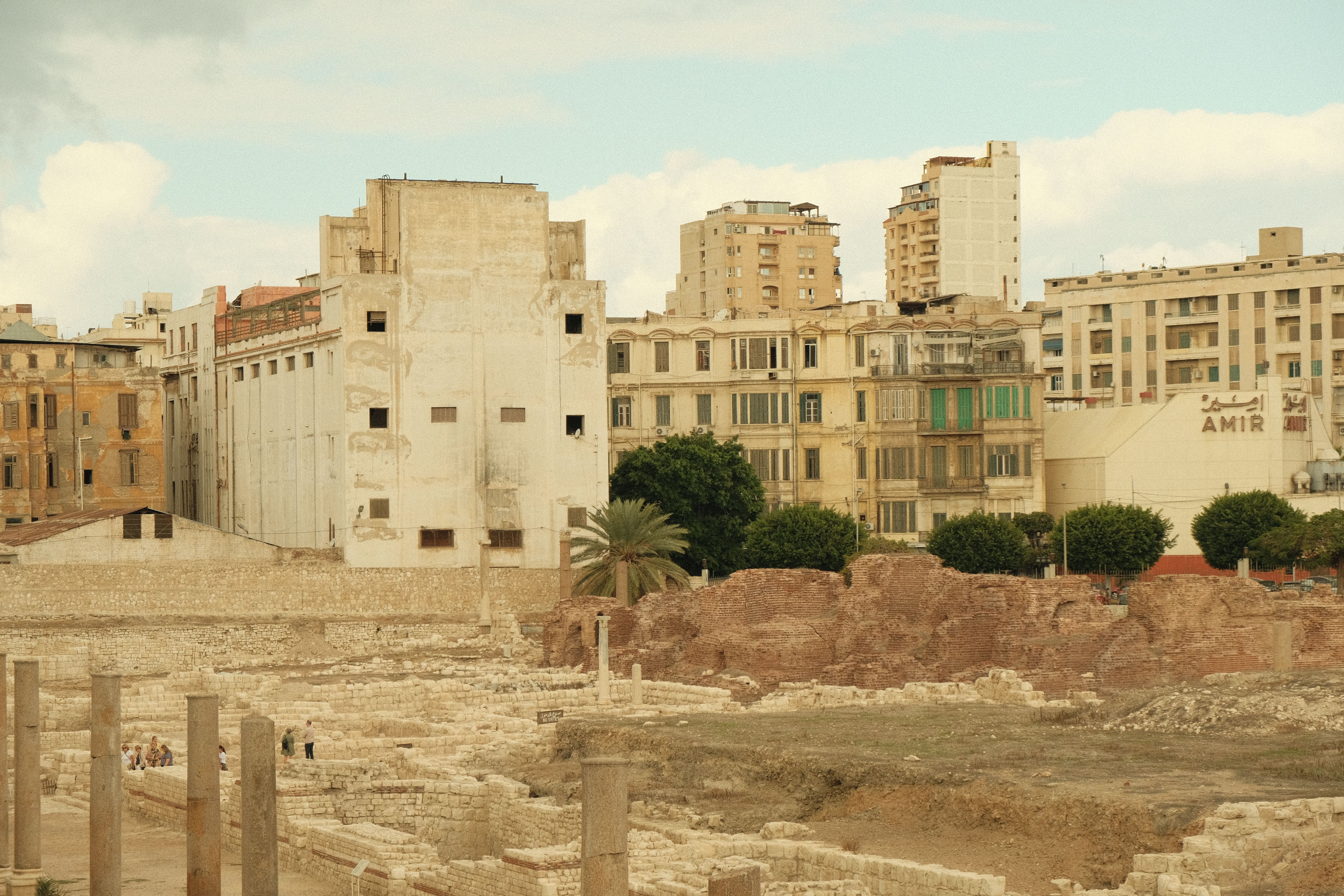 Ancient Roman Ruins Amidst Modern Urban Skyline · Free Stock Photo