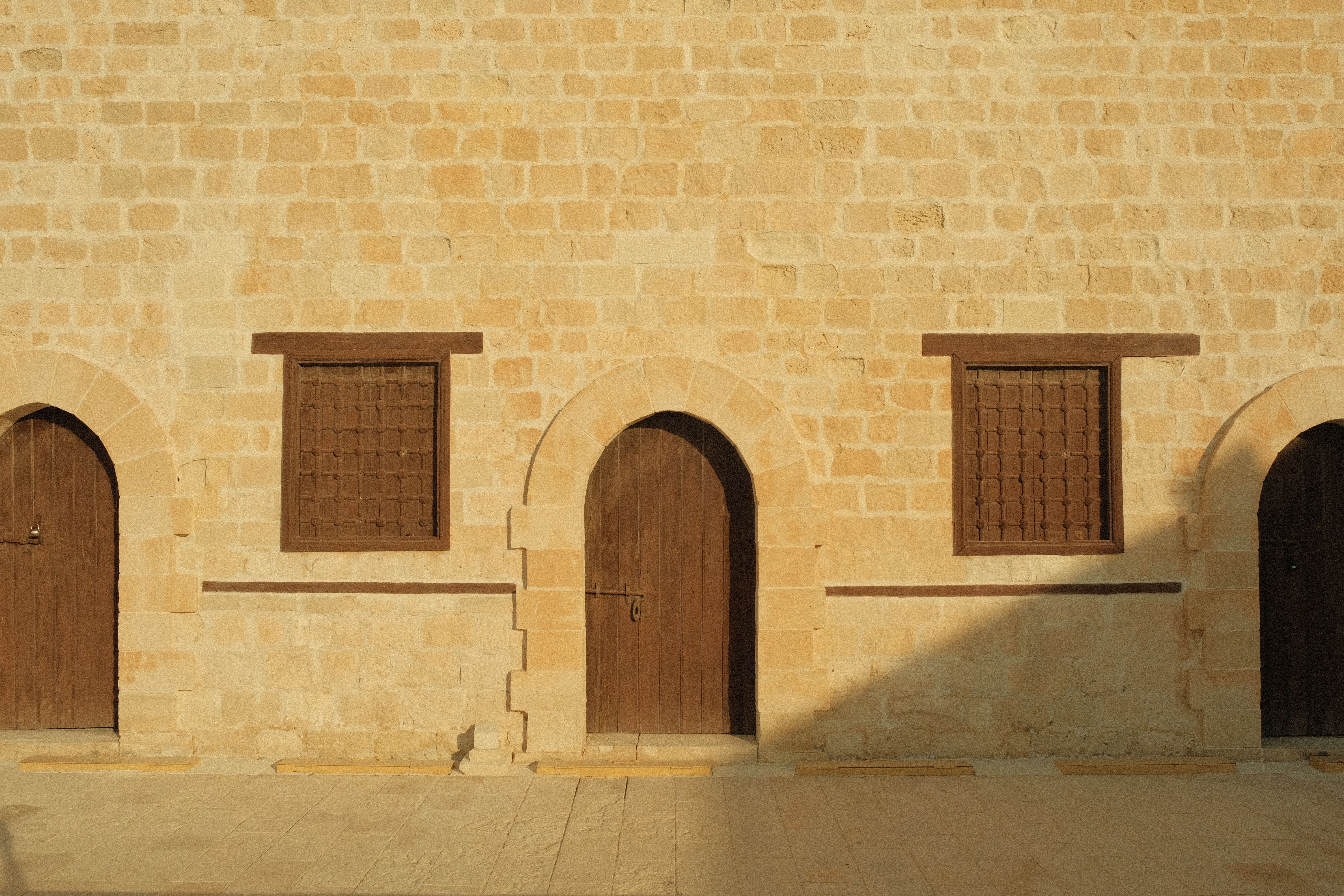 Historic Stone Building with Wooden Doors · Free Stock Photo