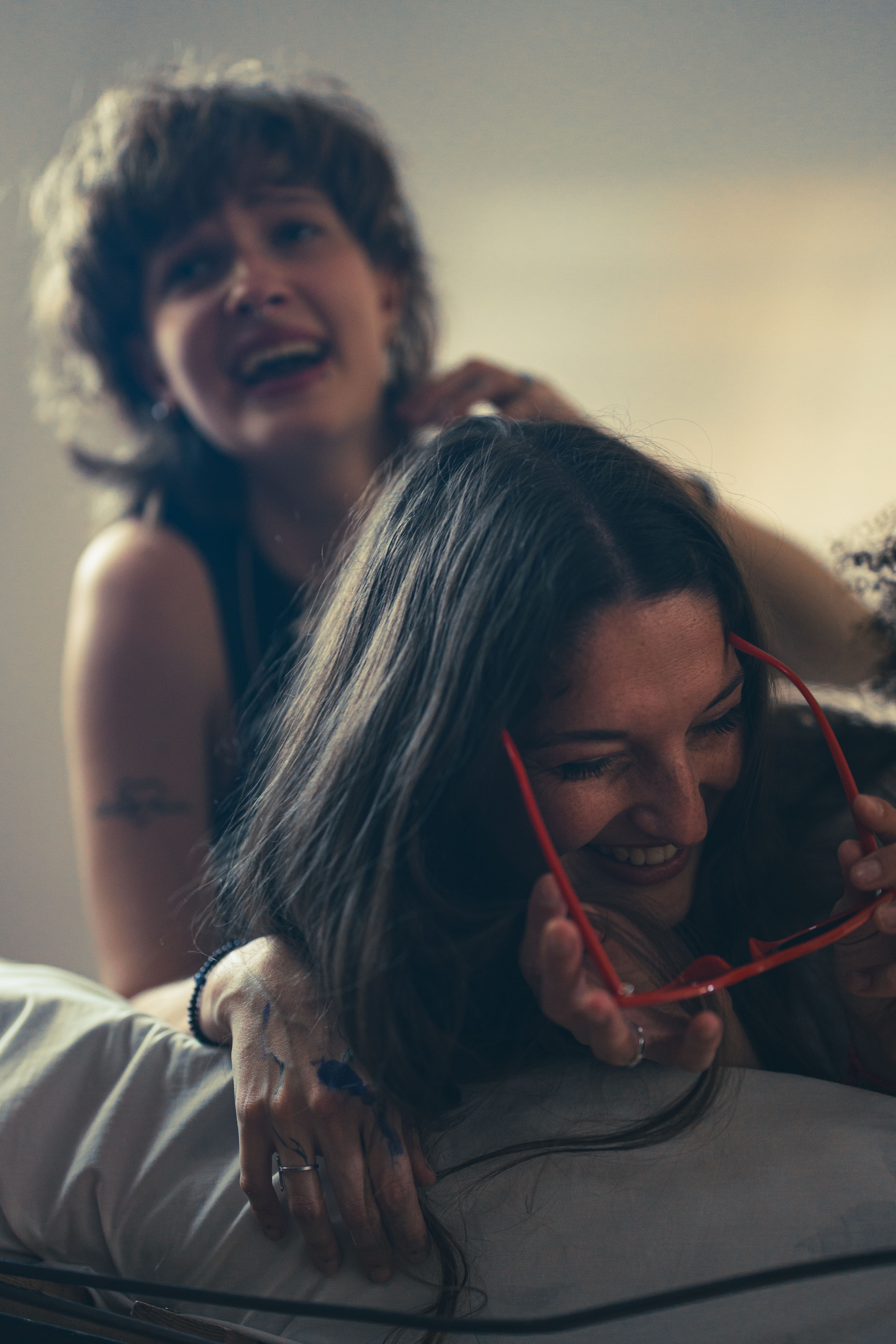 Joyful Friends Sharing Laughter Indoors · Free Stock Photo