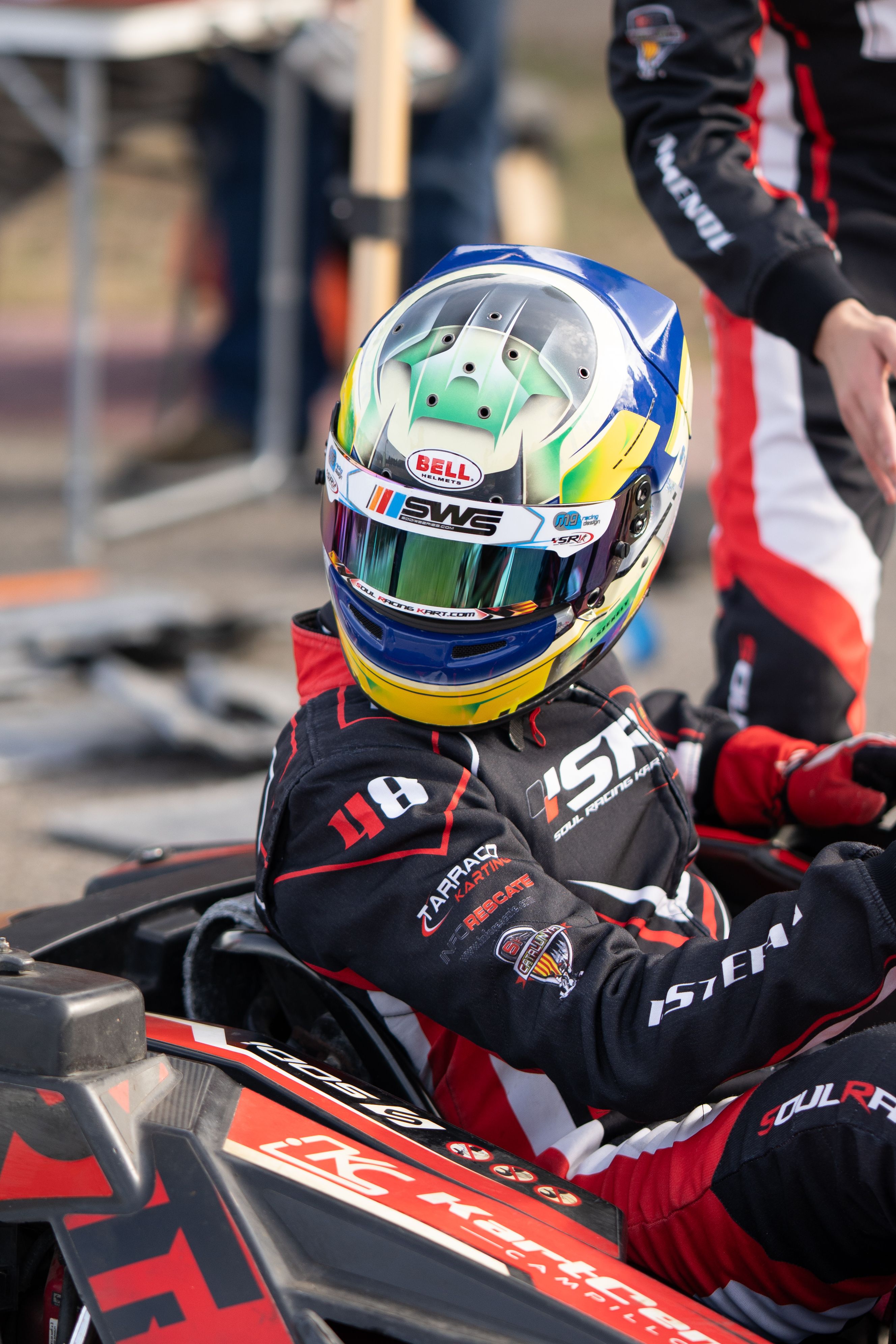 Kart Racing Driver in Action with Colorful Helmet · Free Stock Photo