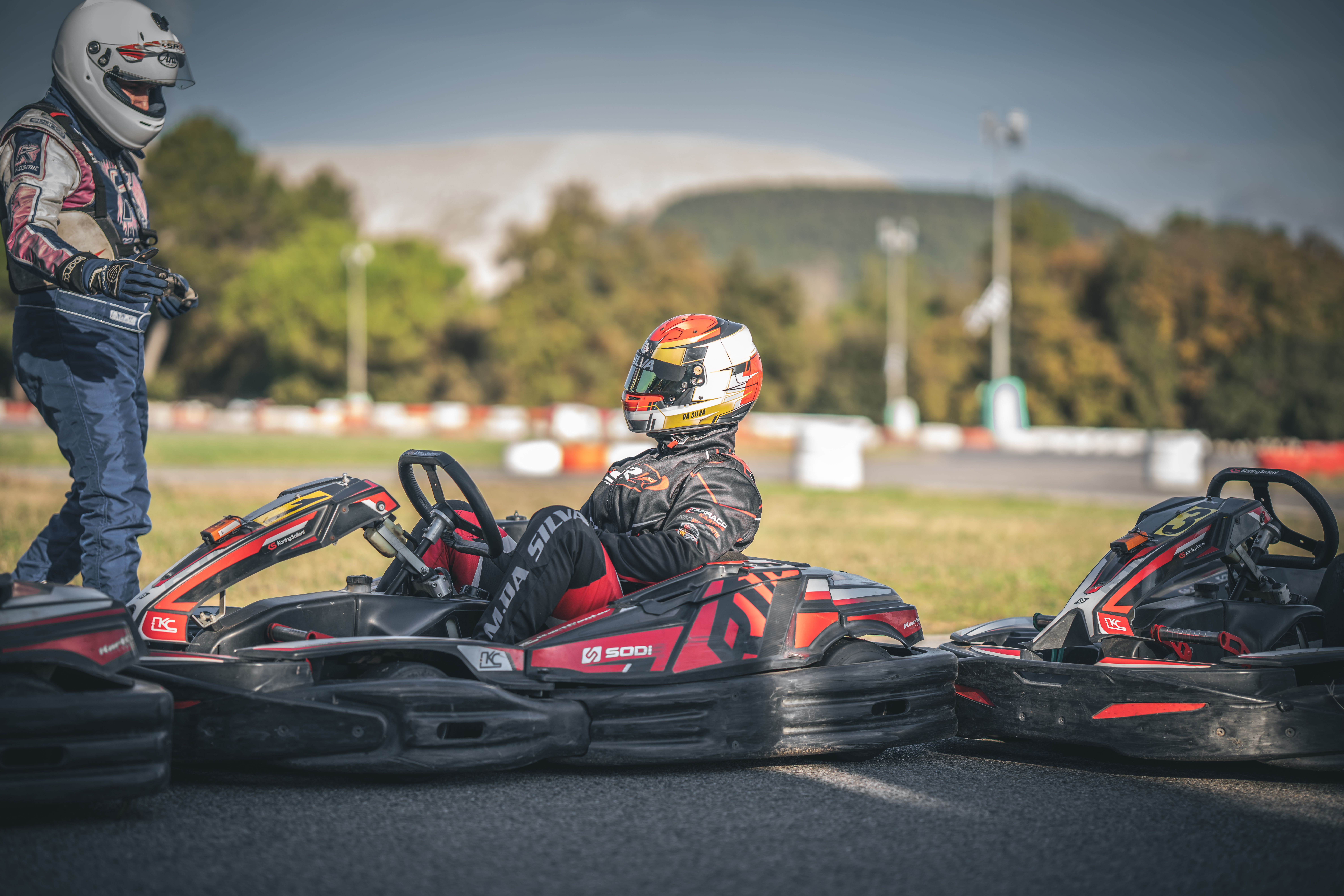 Go-Karting Action at Outdoor Race Track · Free Stock Photo