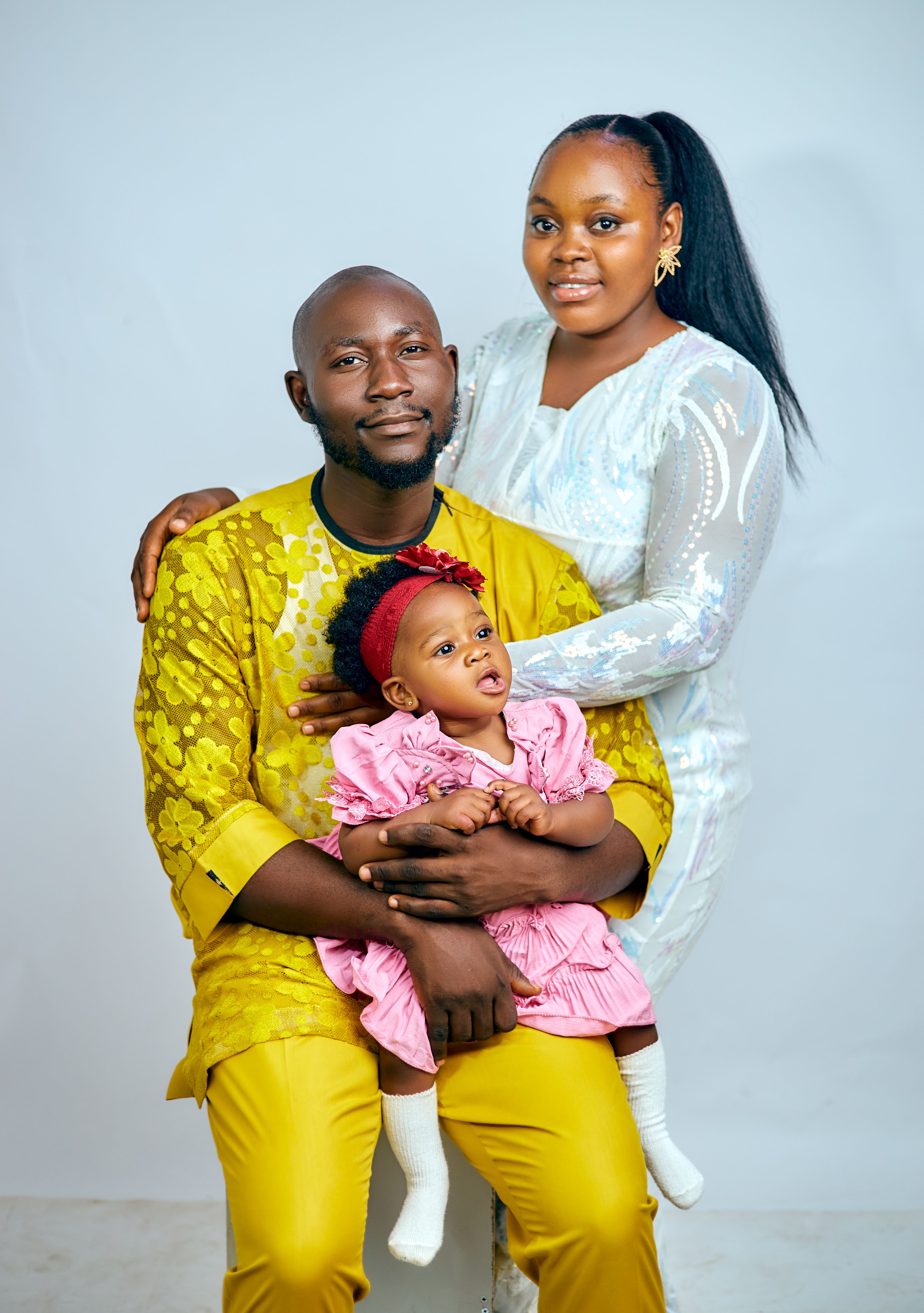 Happy Family Portrait in Vibrant Traditional Attire · Free Stock Photo