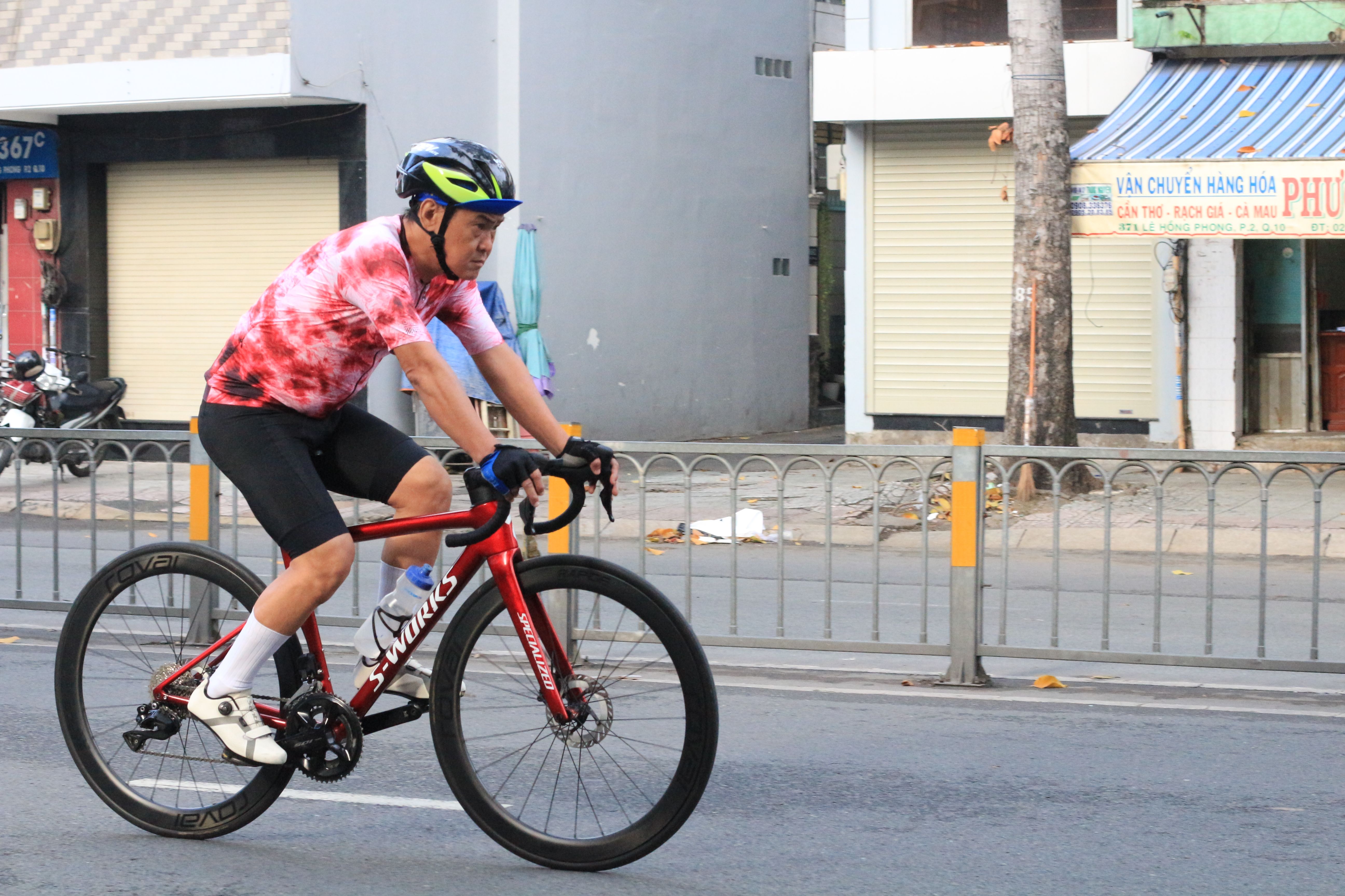 Cyclist Riding Through Ho Chi Minh City Streets · Free Stock Photo
