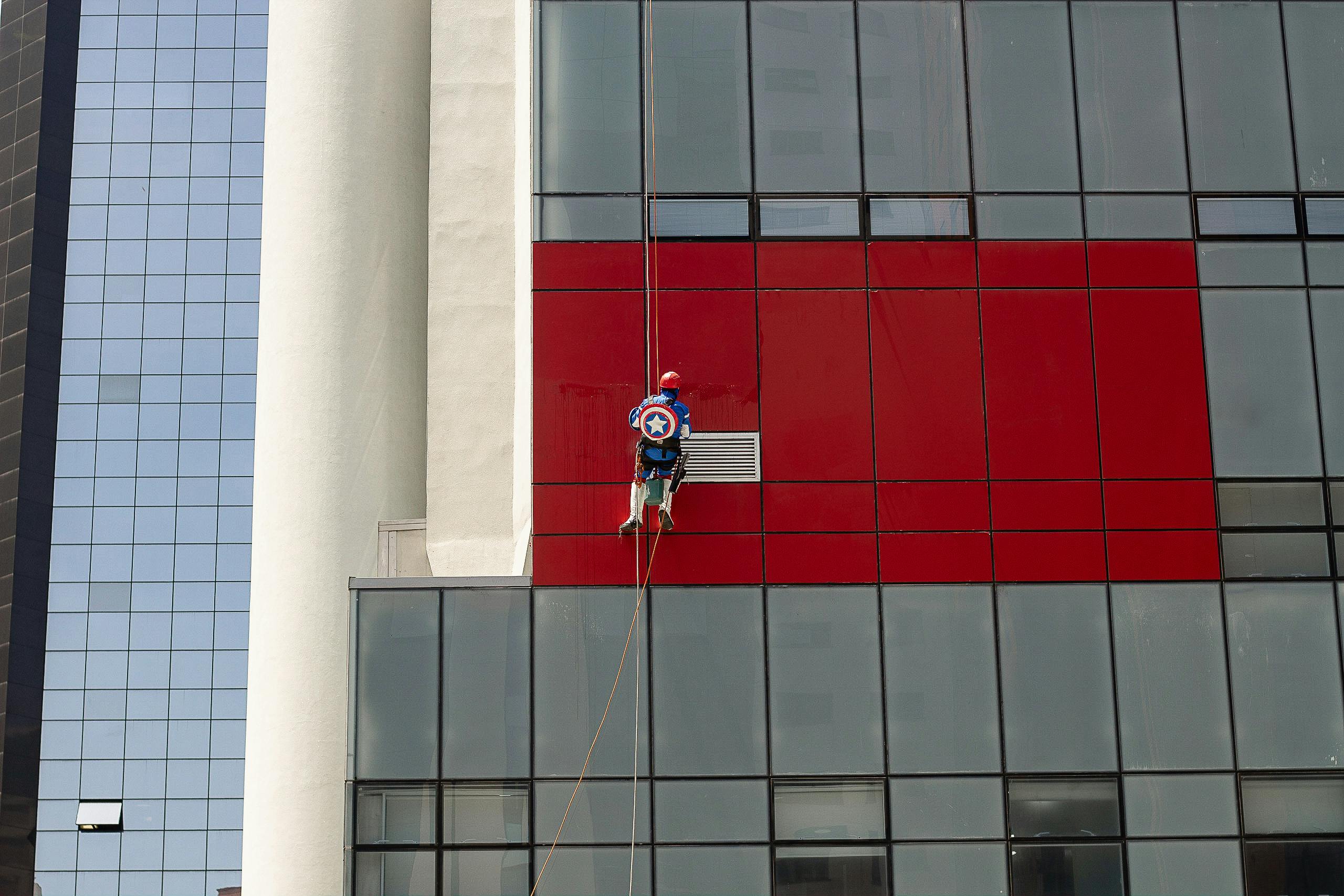 Photo Of Man Cleaning The Building During Daytime · Free Stock Photo