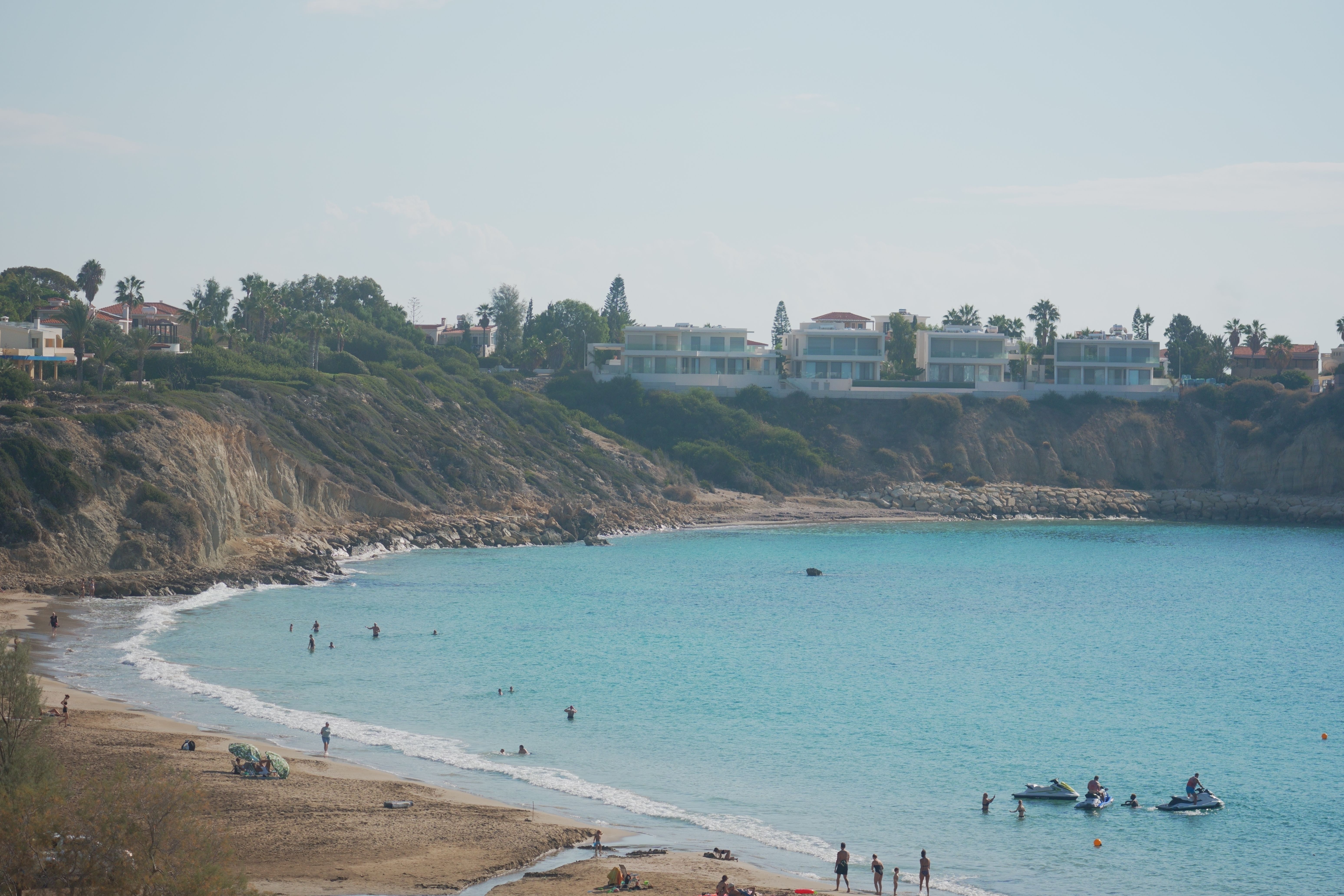 Scenic Beach View with Turquoise Waters and Cliffside Homes · Free ...