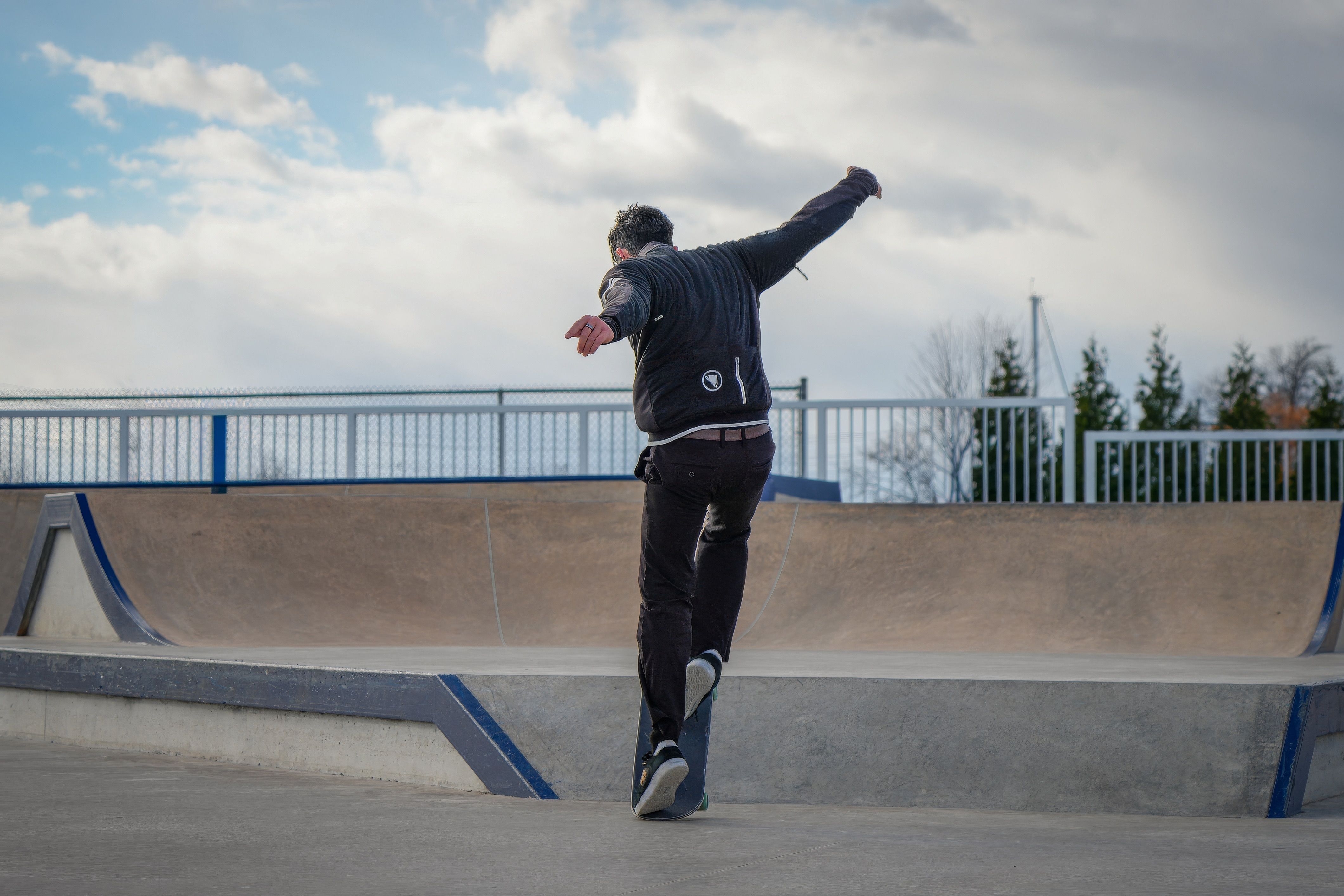 Man Skating in Urban Skate Park on Cloudy Day · Free Stock Photo