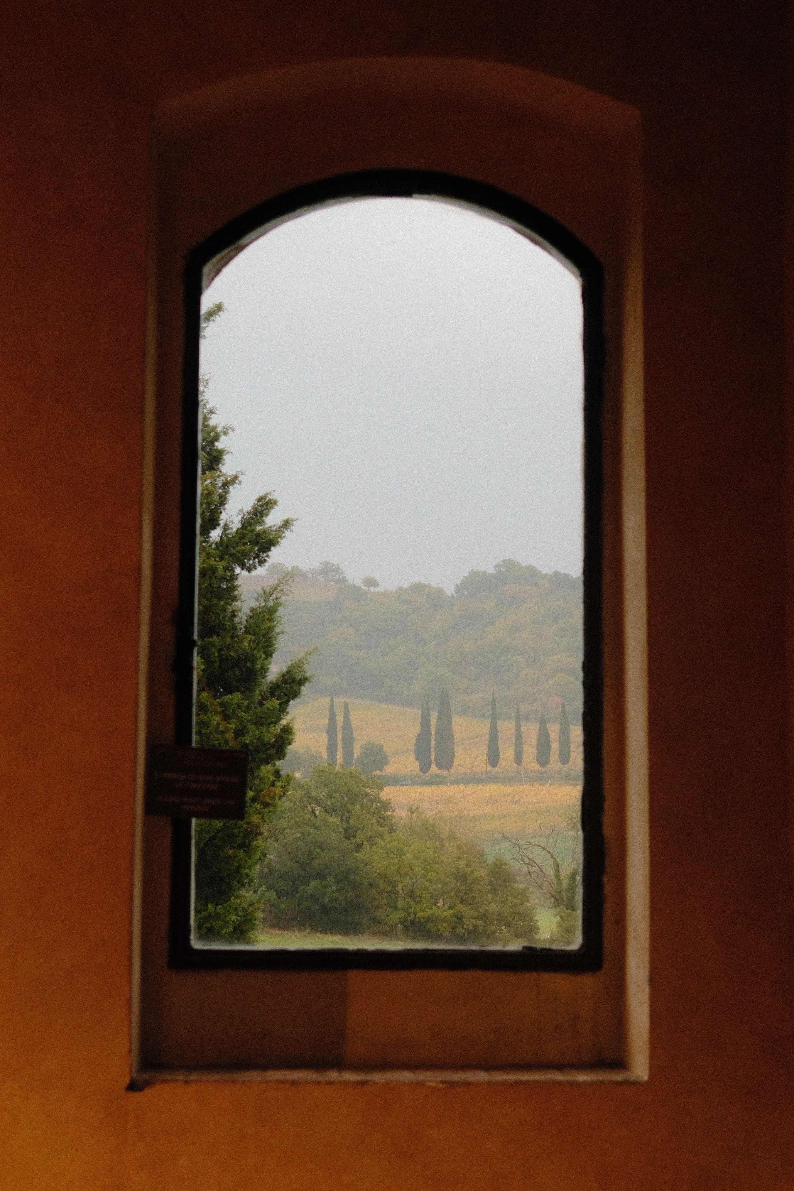 View of Tuscany Landscape Through Arched Window · Free Stock Photo