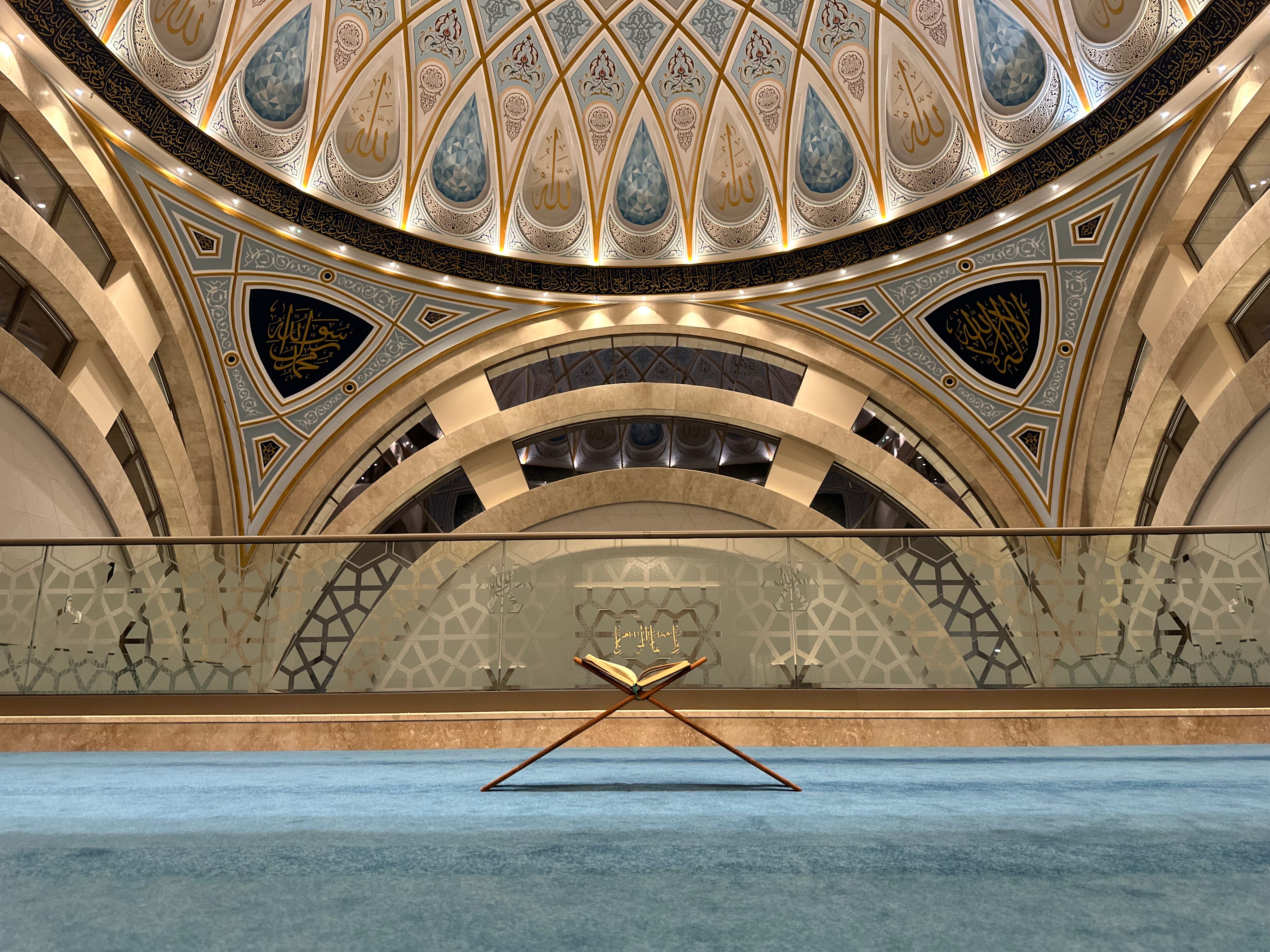 Intricate Mosque Interior with Quran Display · Free Stock Photo