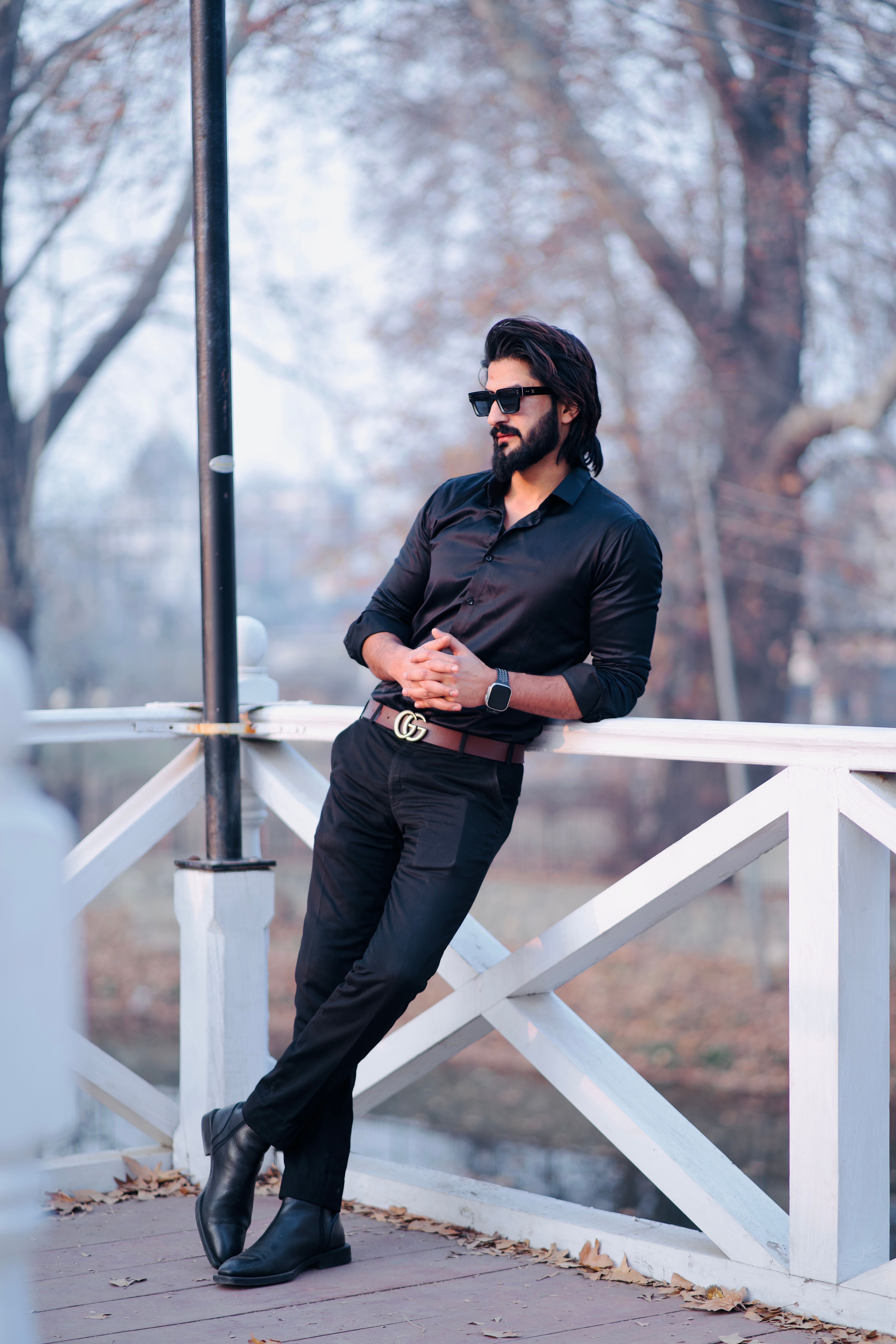 Stylish Man Posing Outdoors on a Bridge · Free Stock Photo