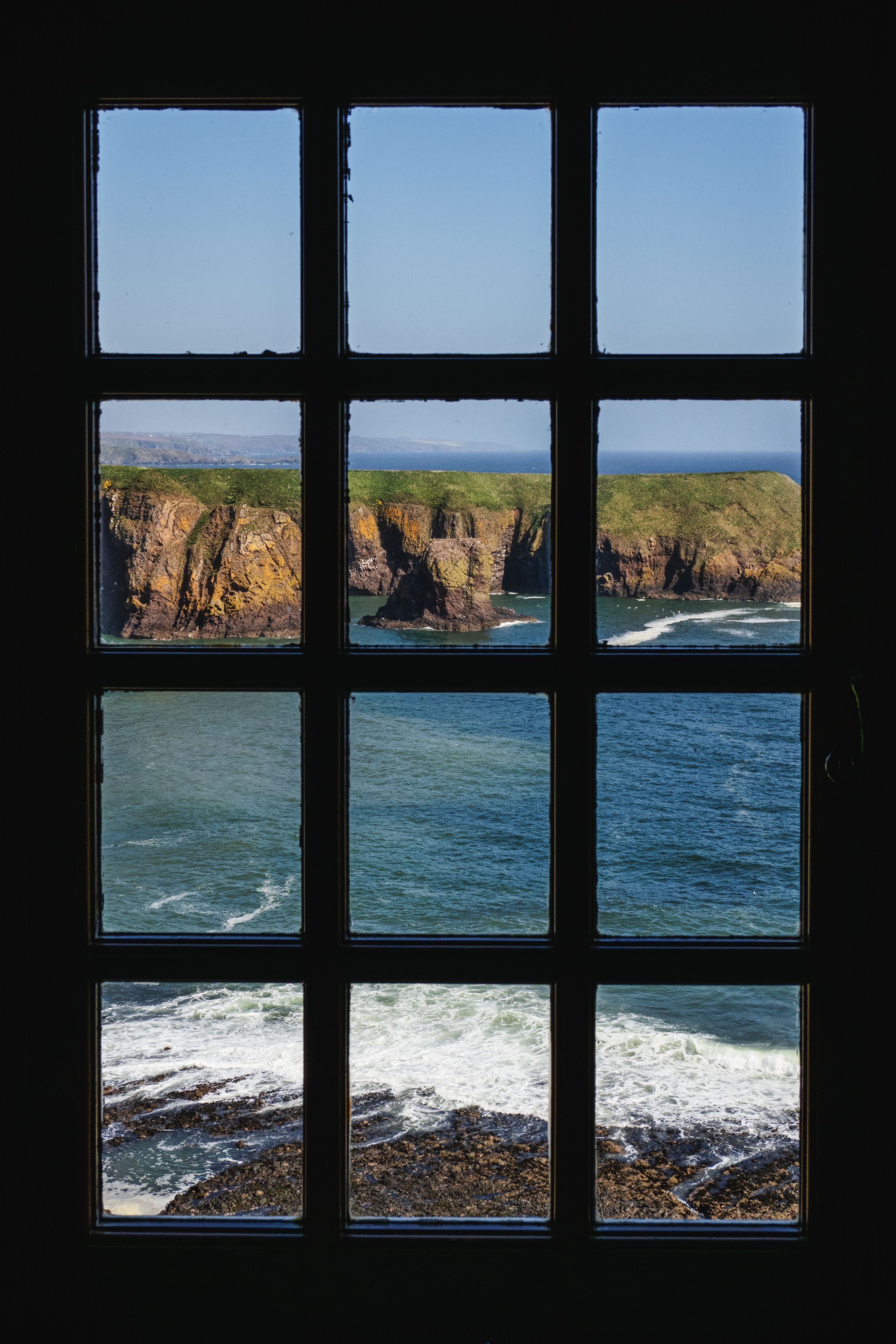 Scenic Ocean View Through Multi-Pane Window · Free Stock Photo