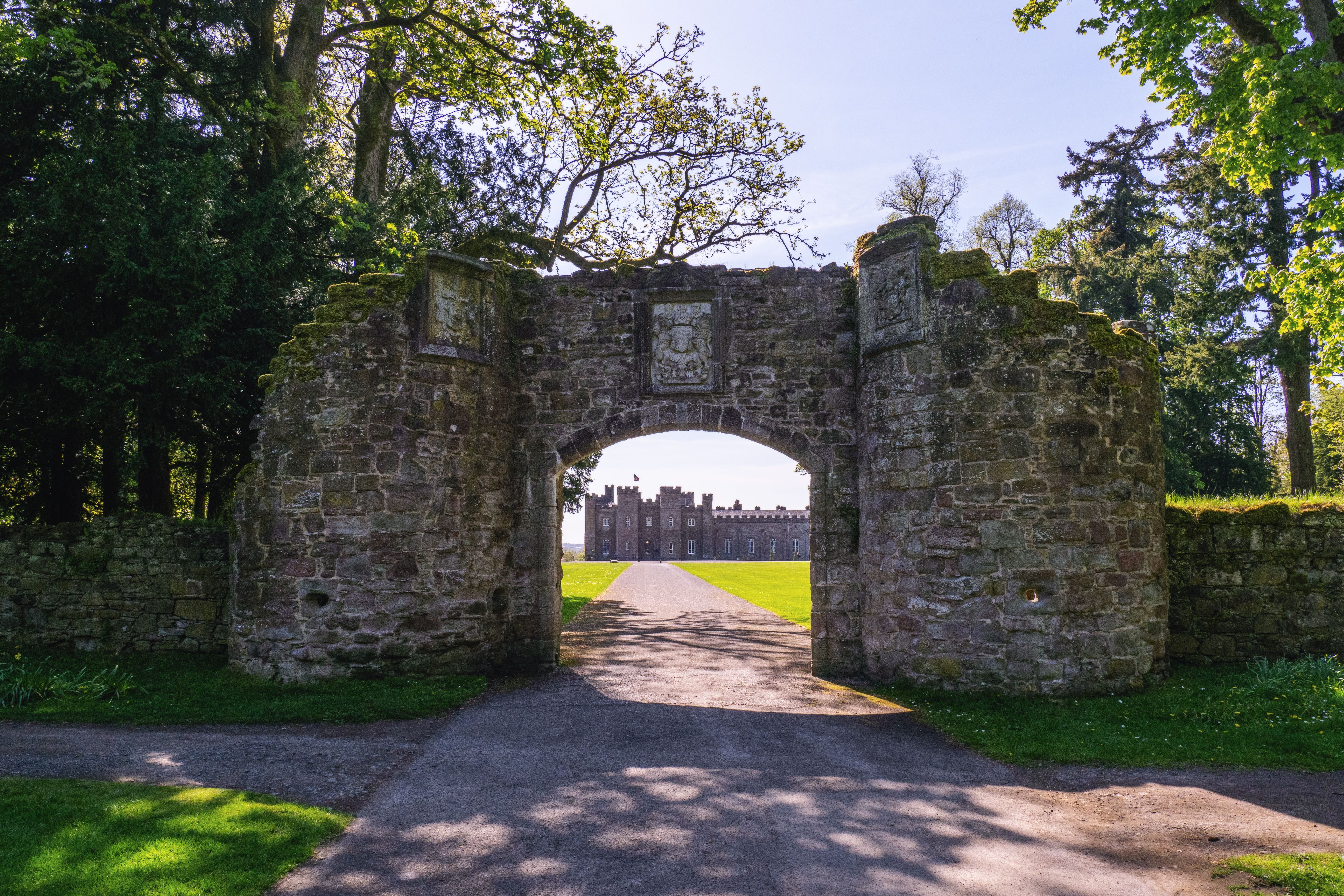 Historic Castle View Through Stone Archway · Free Stock Photo