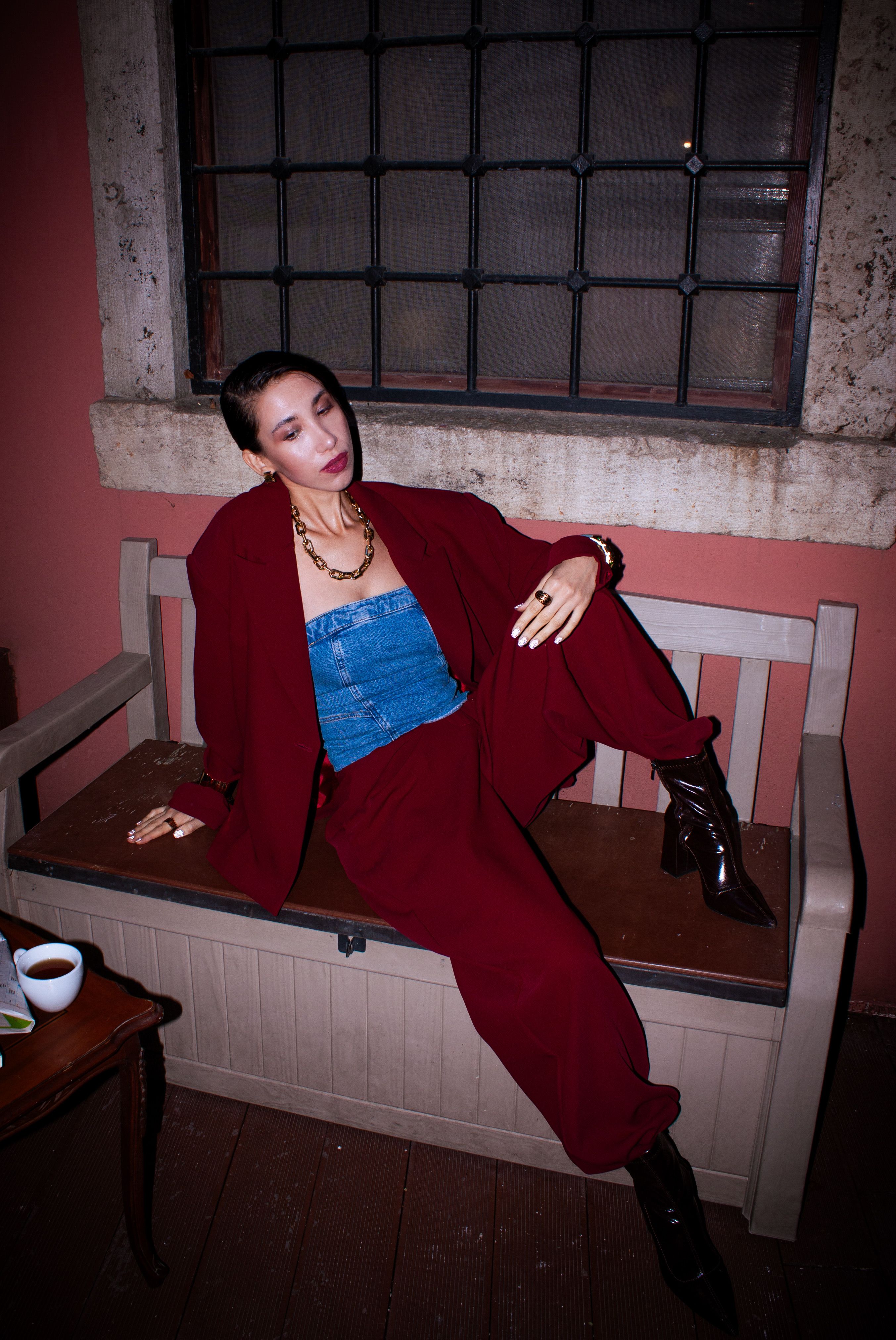 Chic Woman in Red Suit Relaxing Indoors · Free Stock Photo