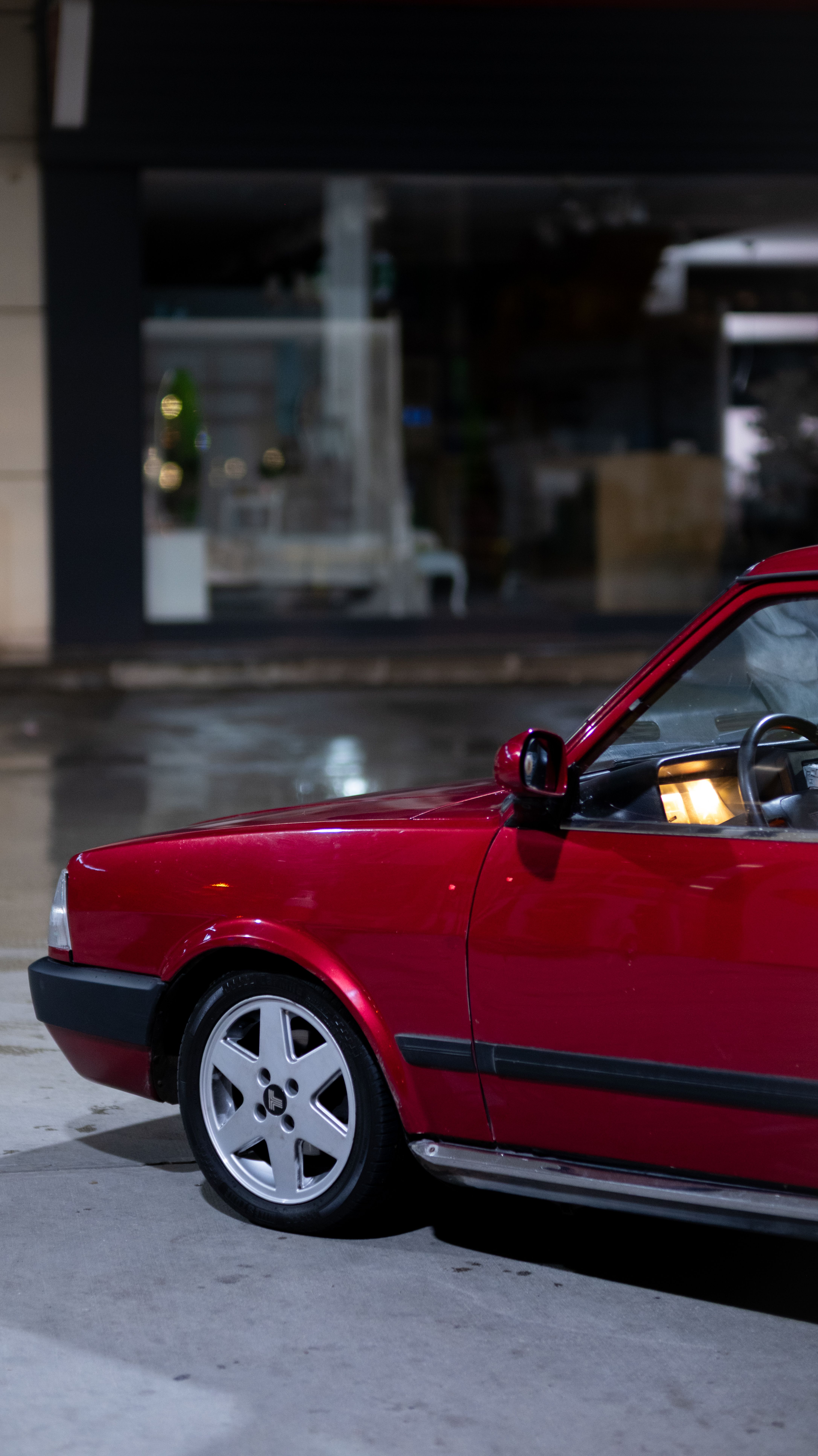 Red Car at Night in Urban Setting · Free Stock Photo