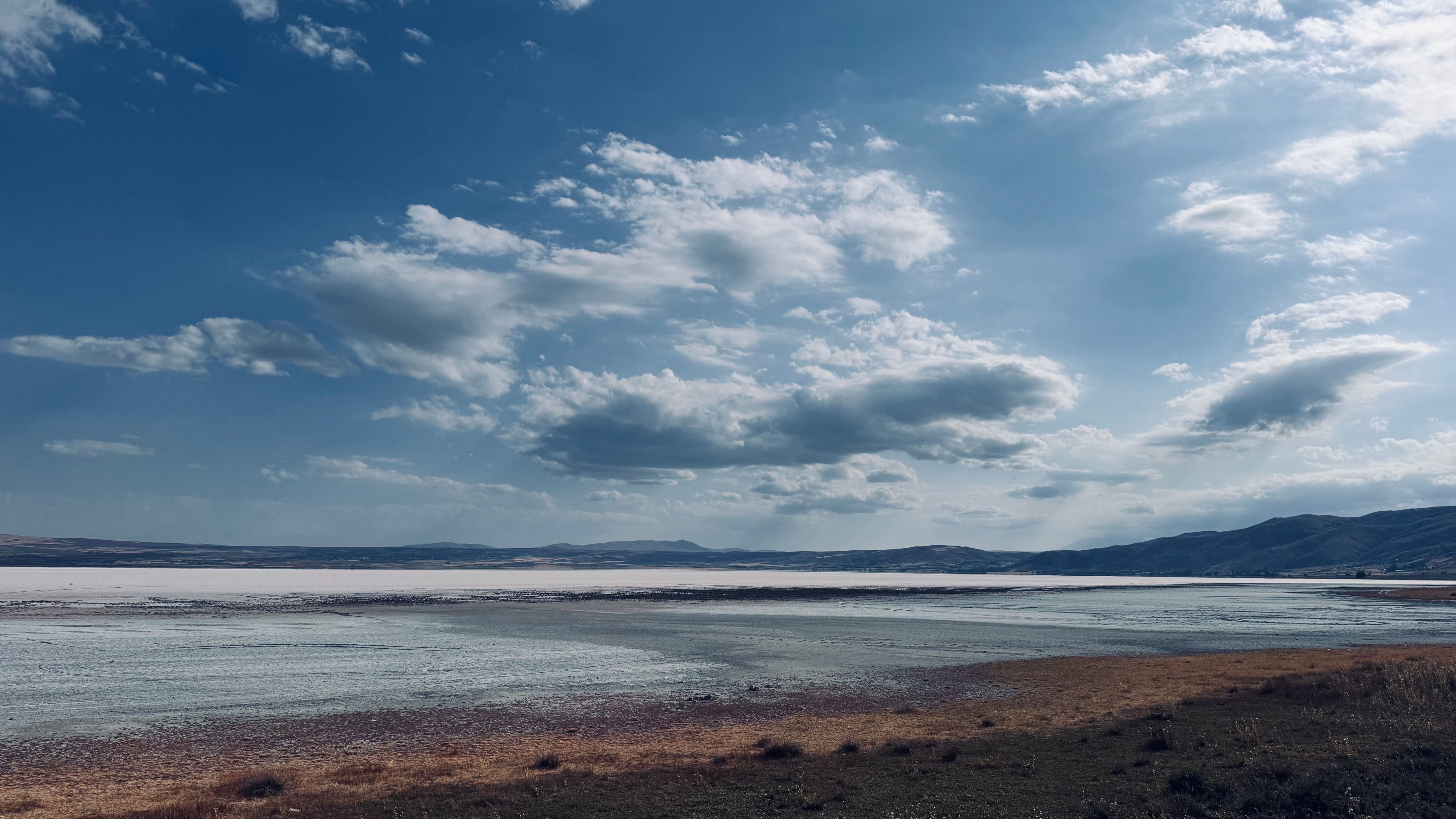 Dramatic Cloudscape Over Serene Salt Flats · Free Stock Photo