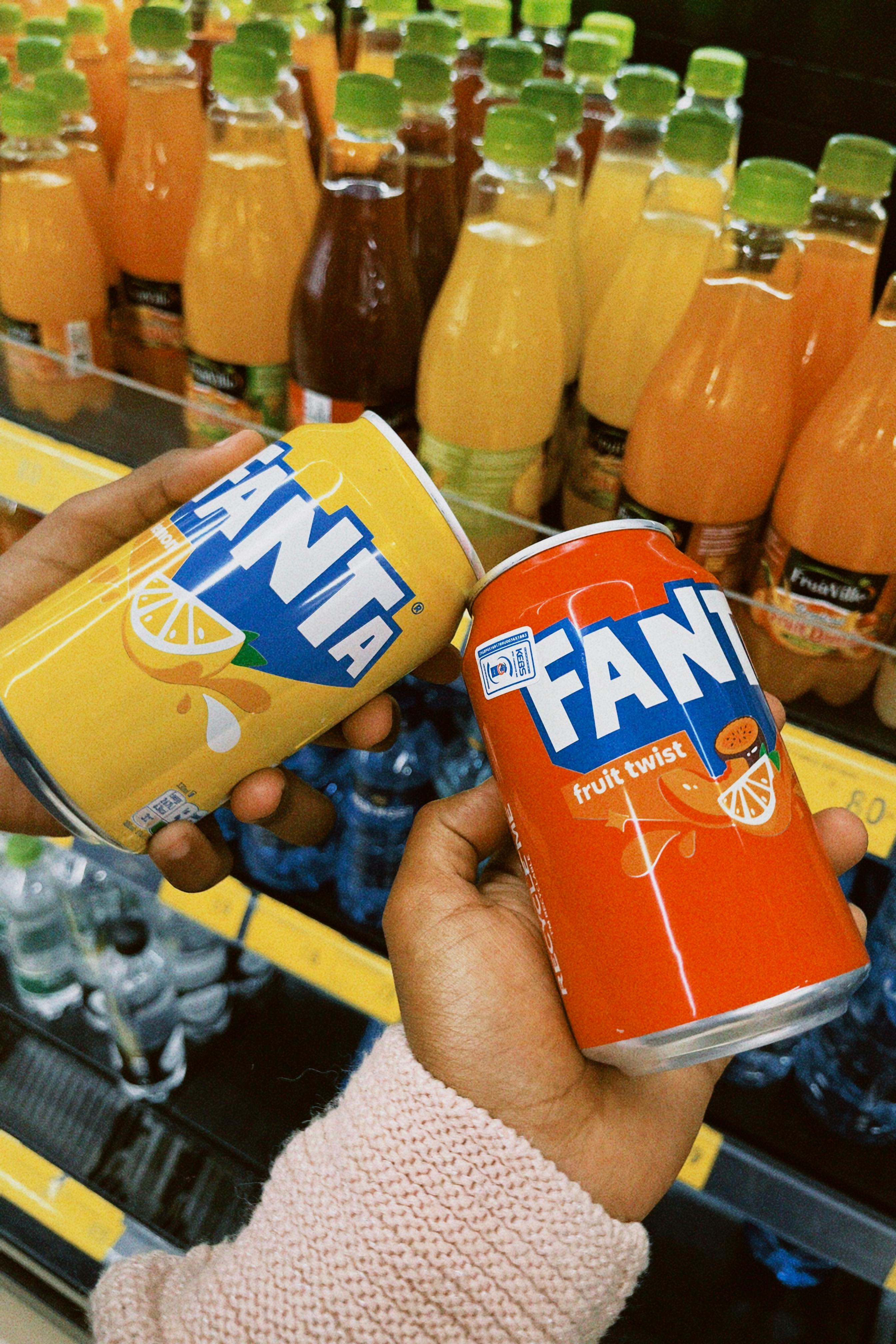 Two Fanta Cans in a Colorful Beverage Display · Free Stock Photo