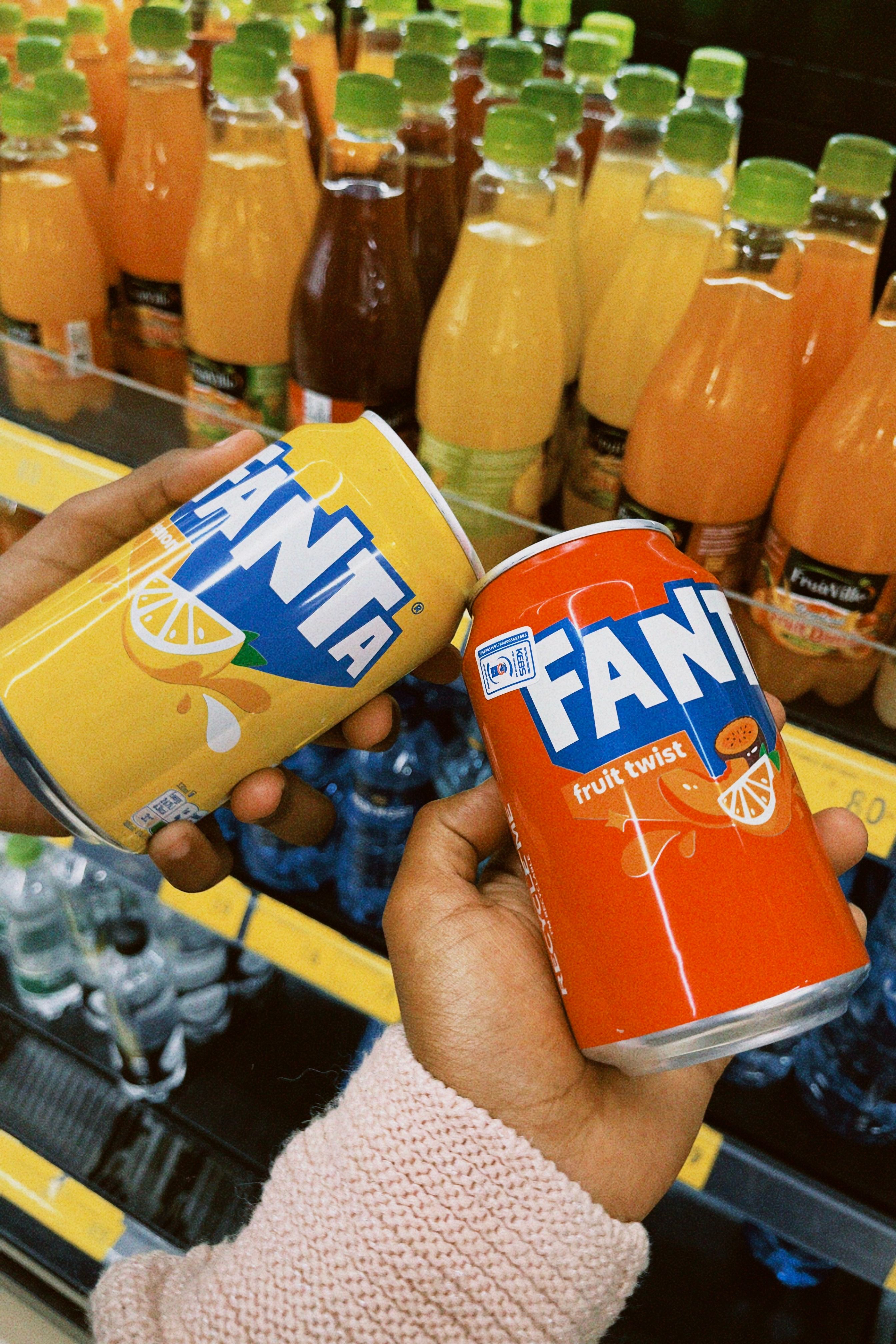 Two Fanta Cans in a Colorful Beverage Display · Free Stock Photo