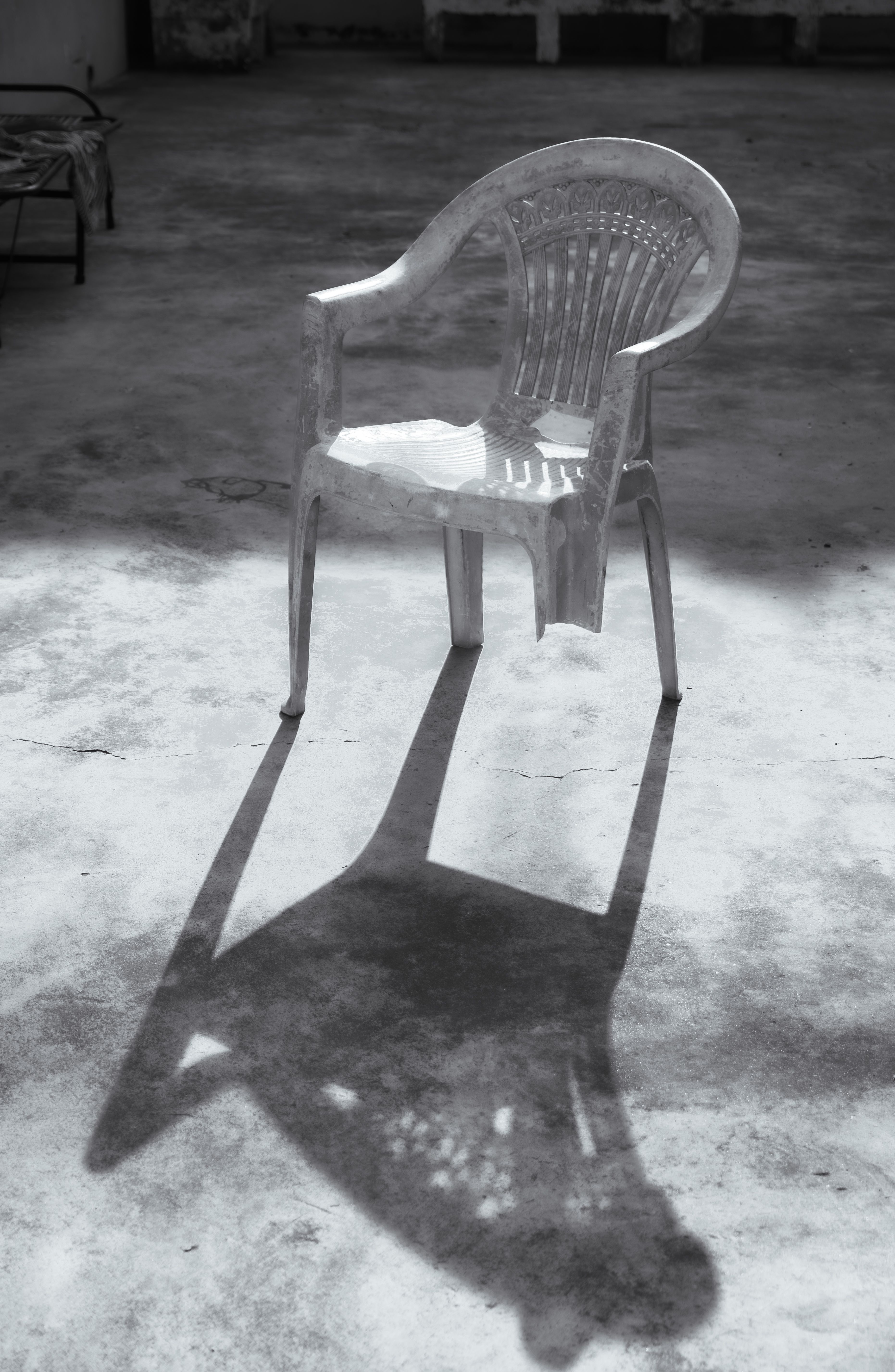 Modern Plastic Chair with Dramatic Shadow · Free Stock Photo