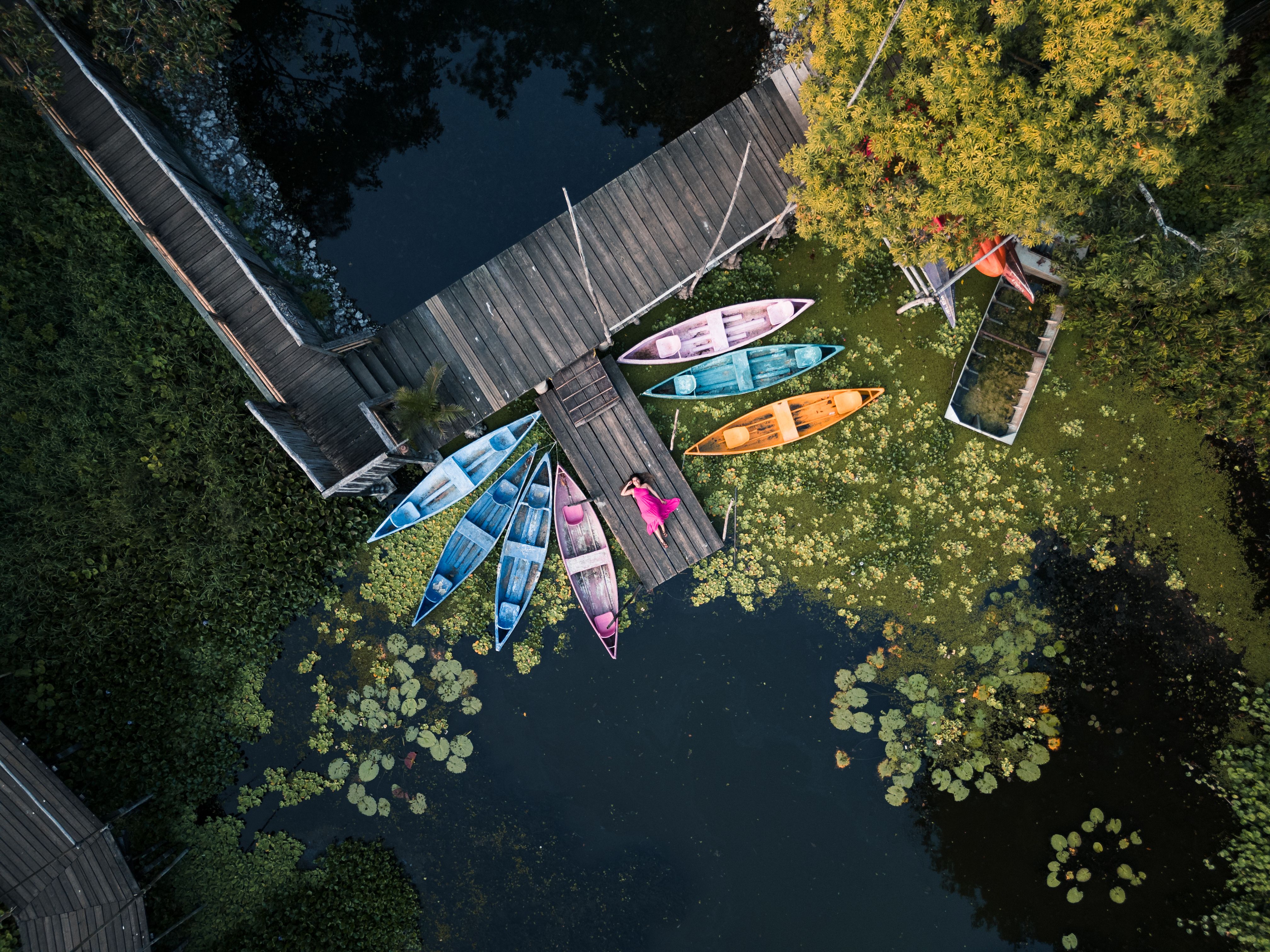 Aerial View of Canoes on Serene Lake Dock · Free Stock Photo