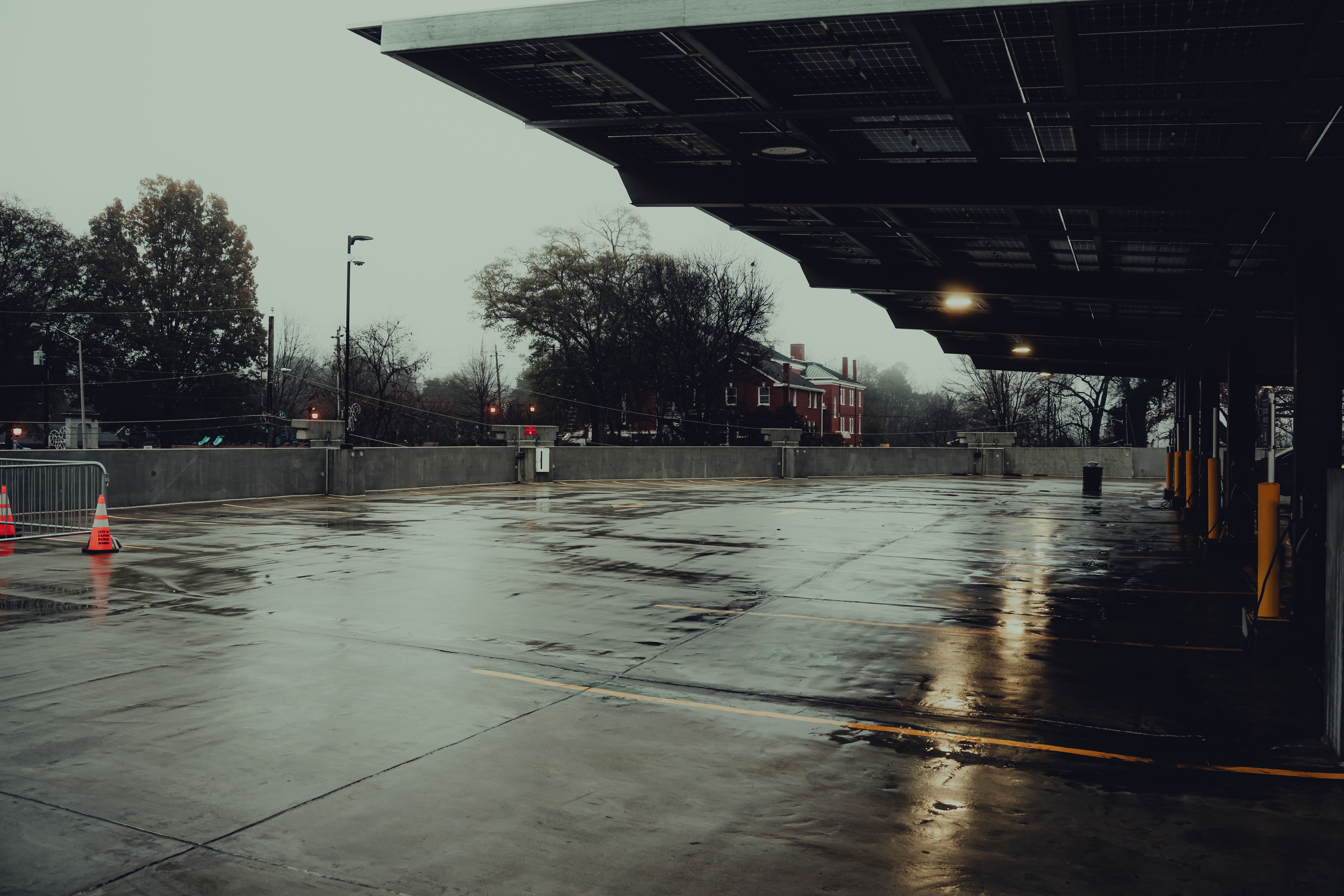 Rainy Urban Parking Lot with Wet Pavement · Free Stock Photo